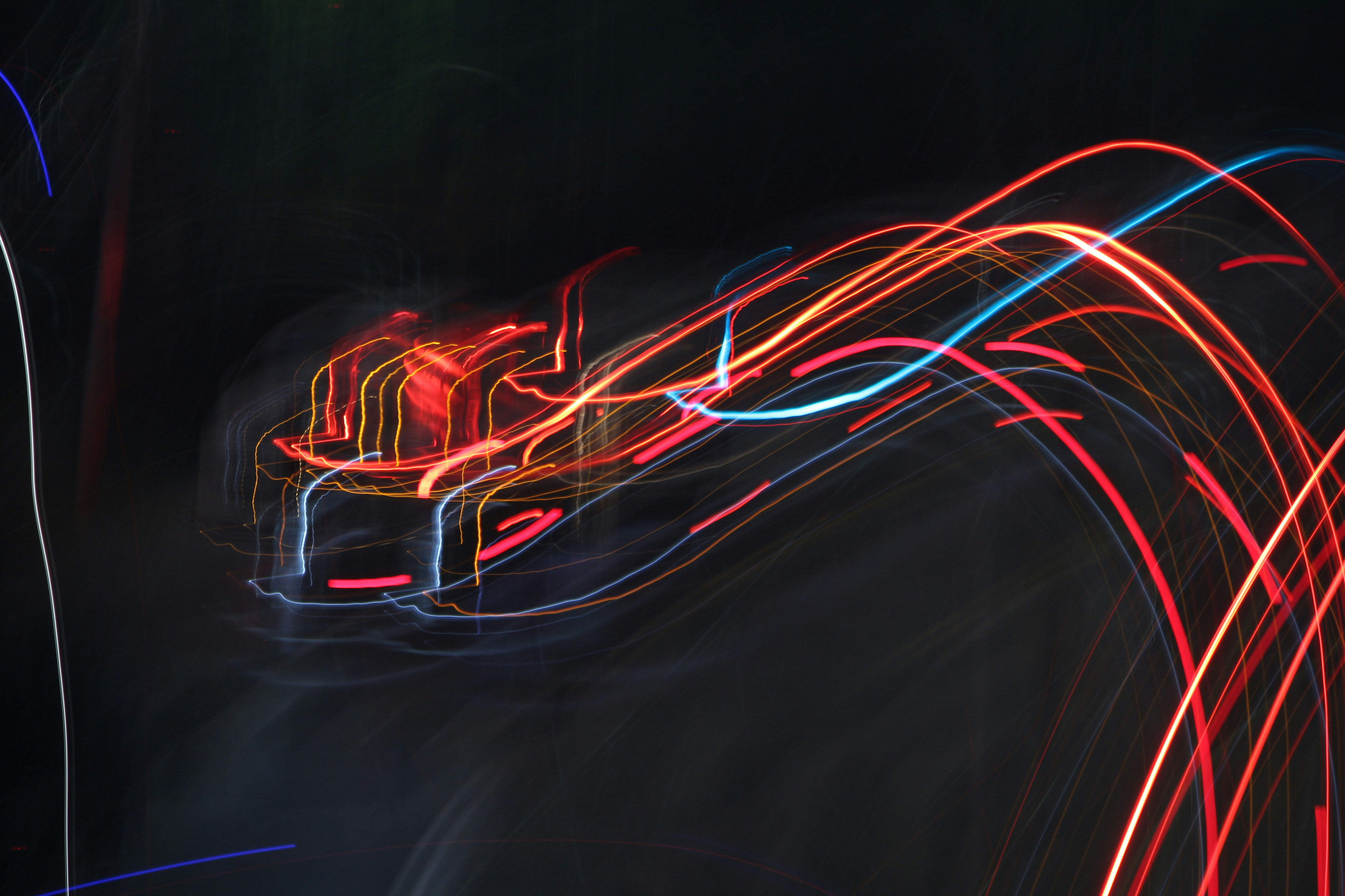 Neon Arcs in Night Motion: A Slow-Shutter Car Light Trail