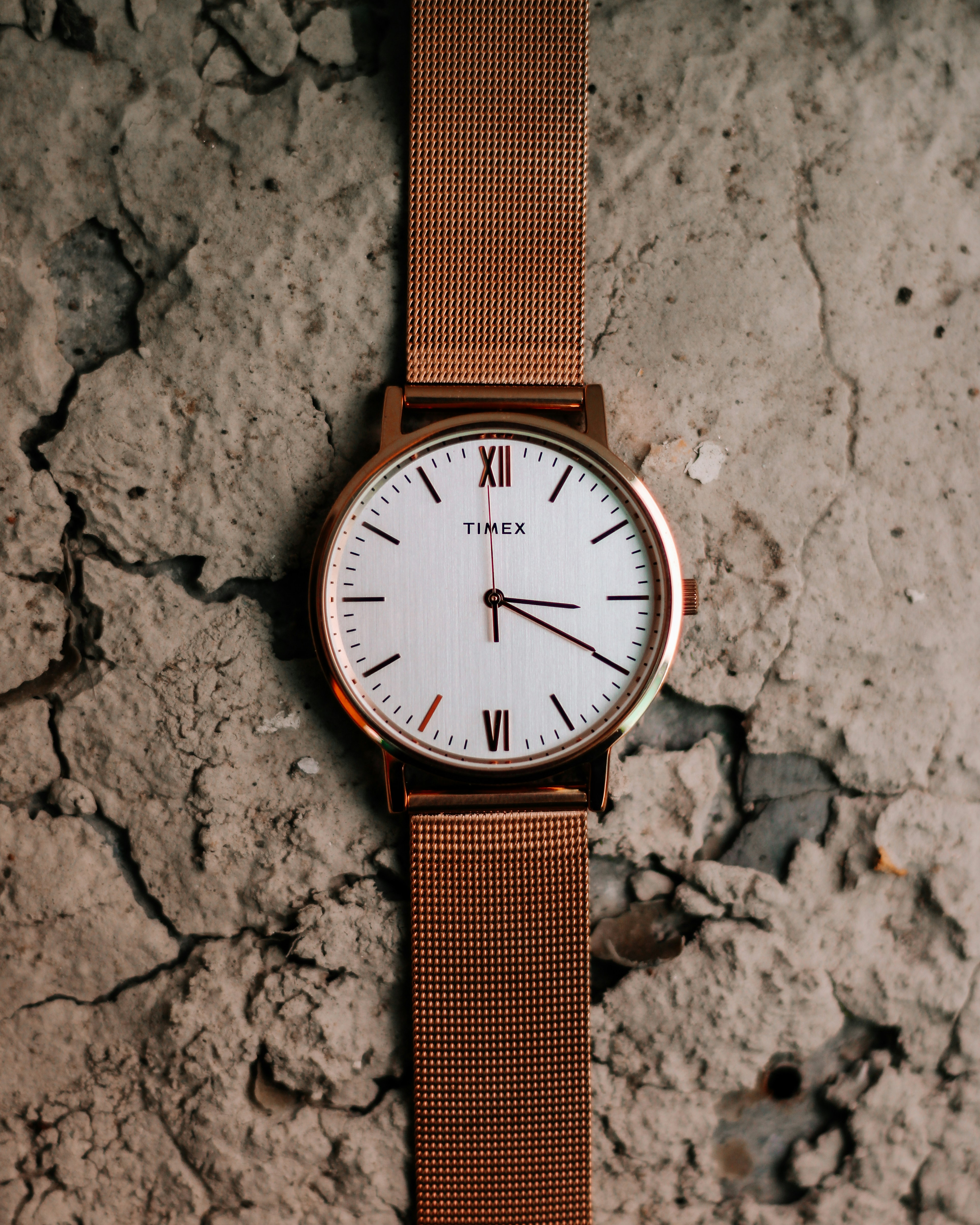 a close up of a wrist watch on a rock