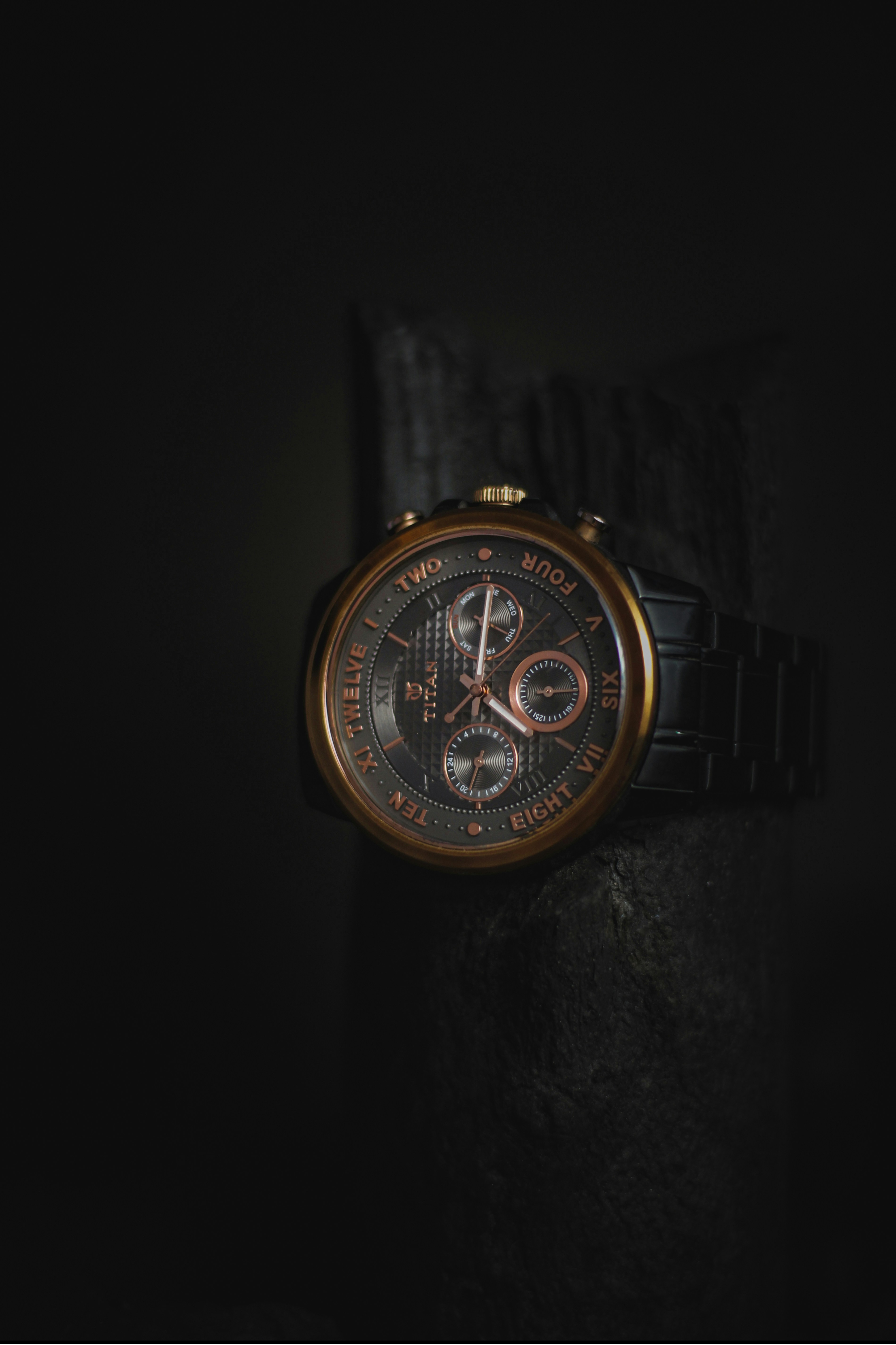 A close up of a watch on a black surface photo – Free Wristwatch Image ...