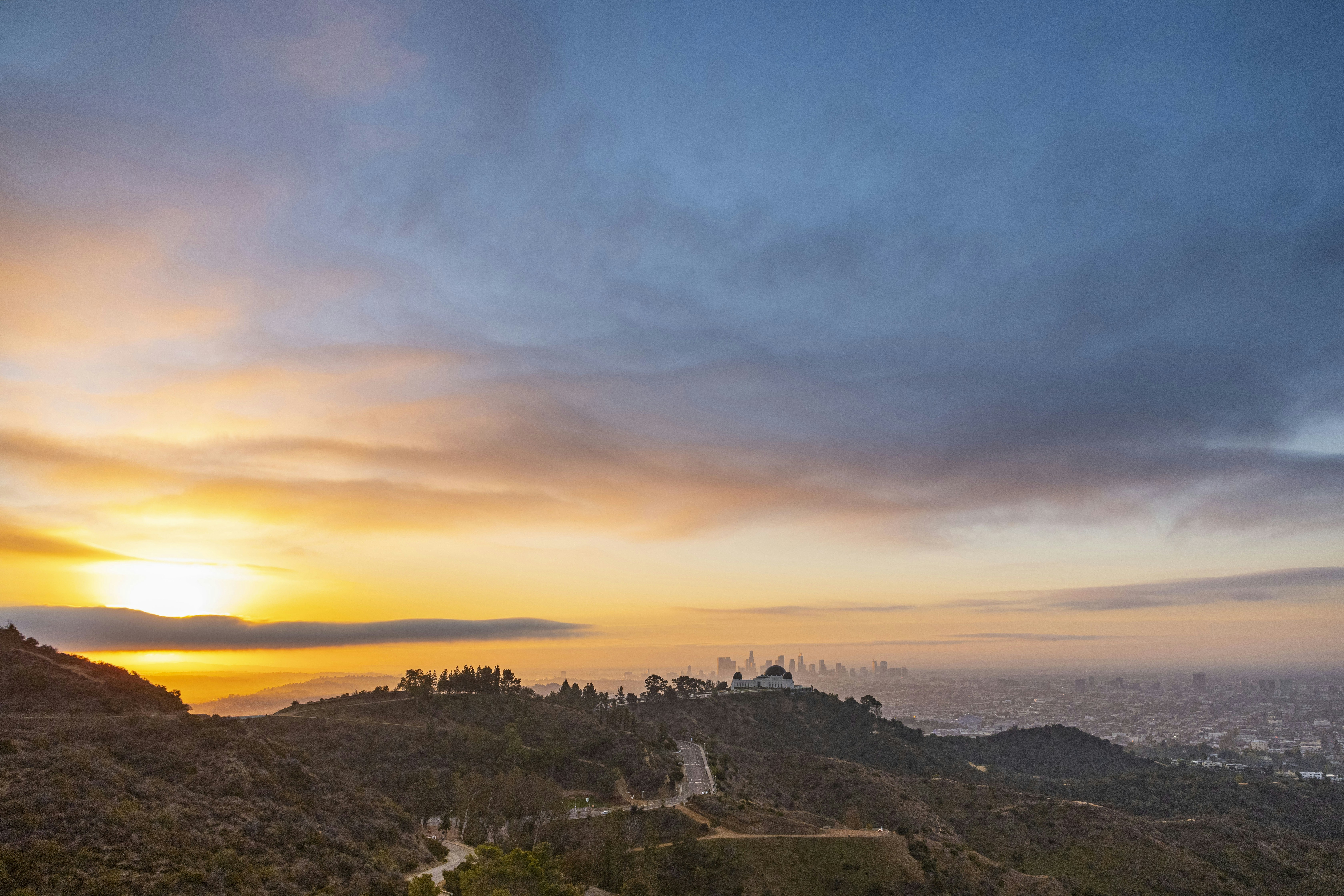 A view of a sunset over a city from a hill photo – Free Griffith ...