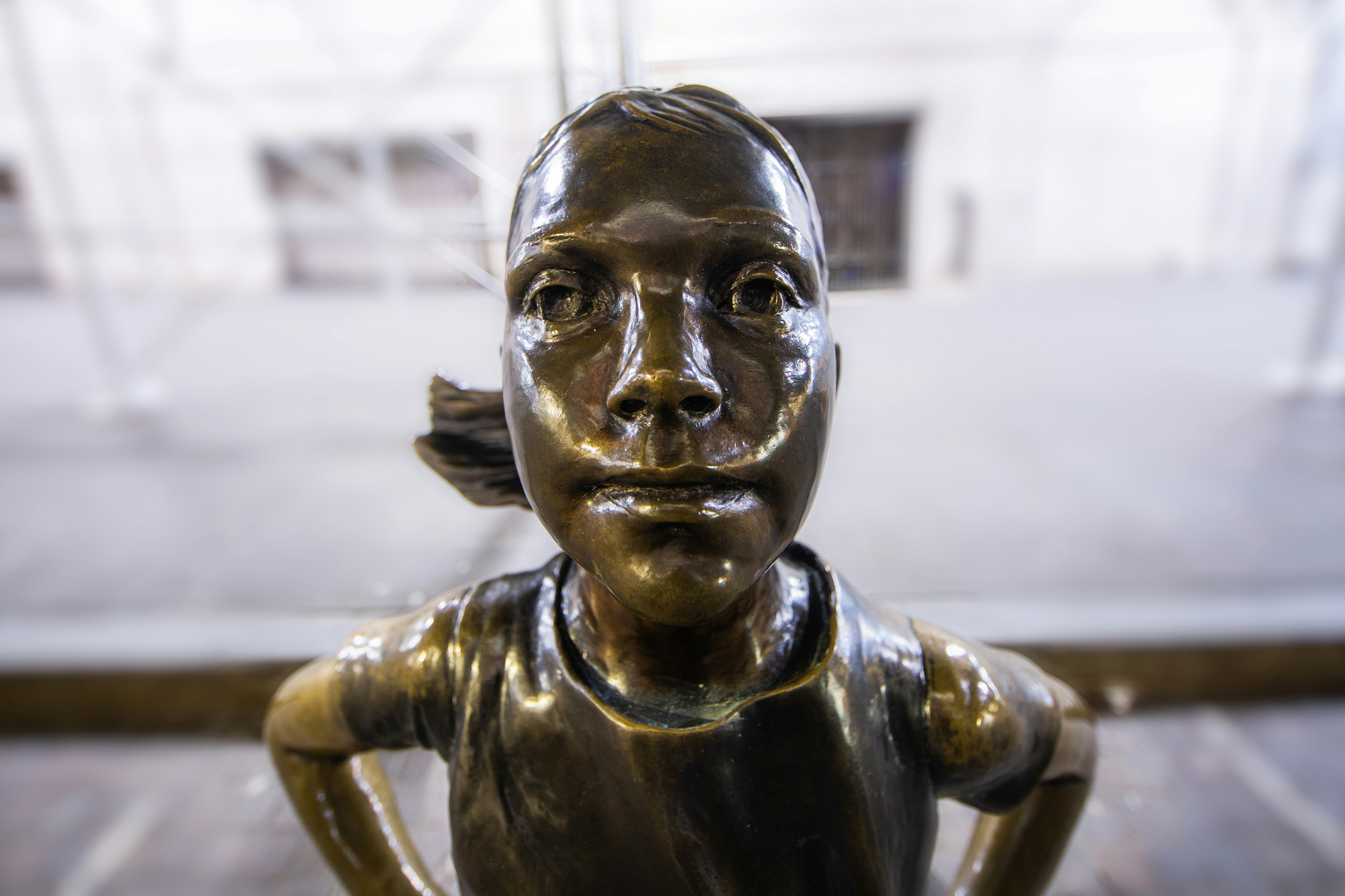 a bronze statue of a woman with her hands on her hips