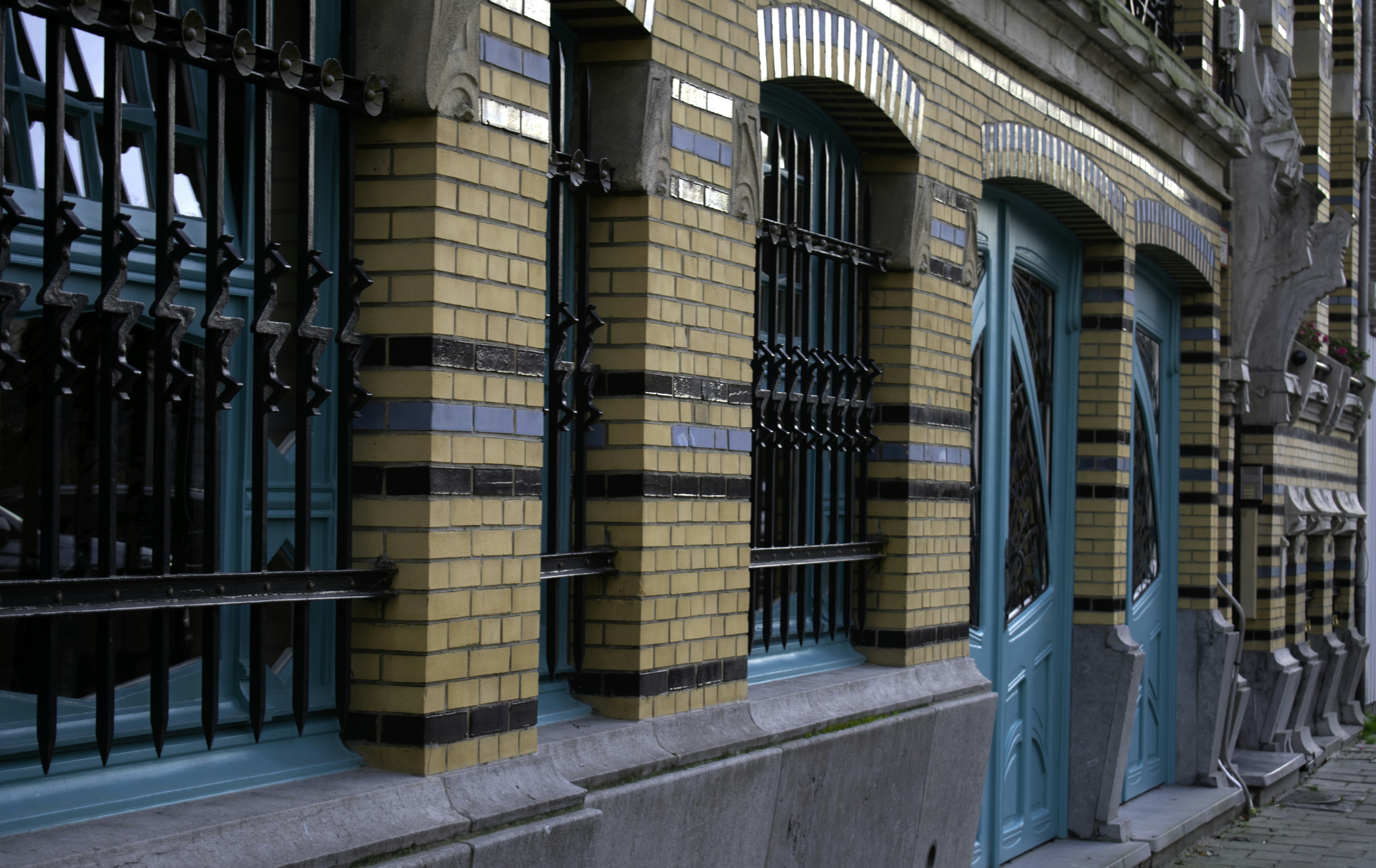A row of windows with bars on each of them photo – Free Grey Image on ...