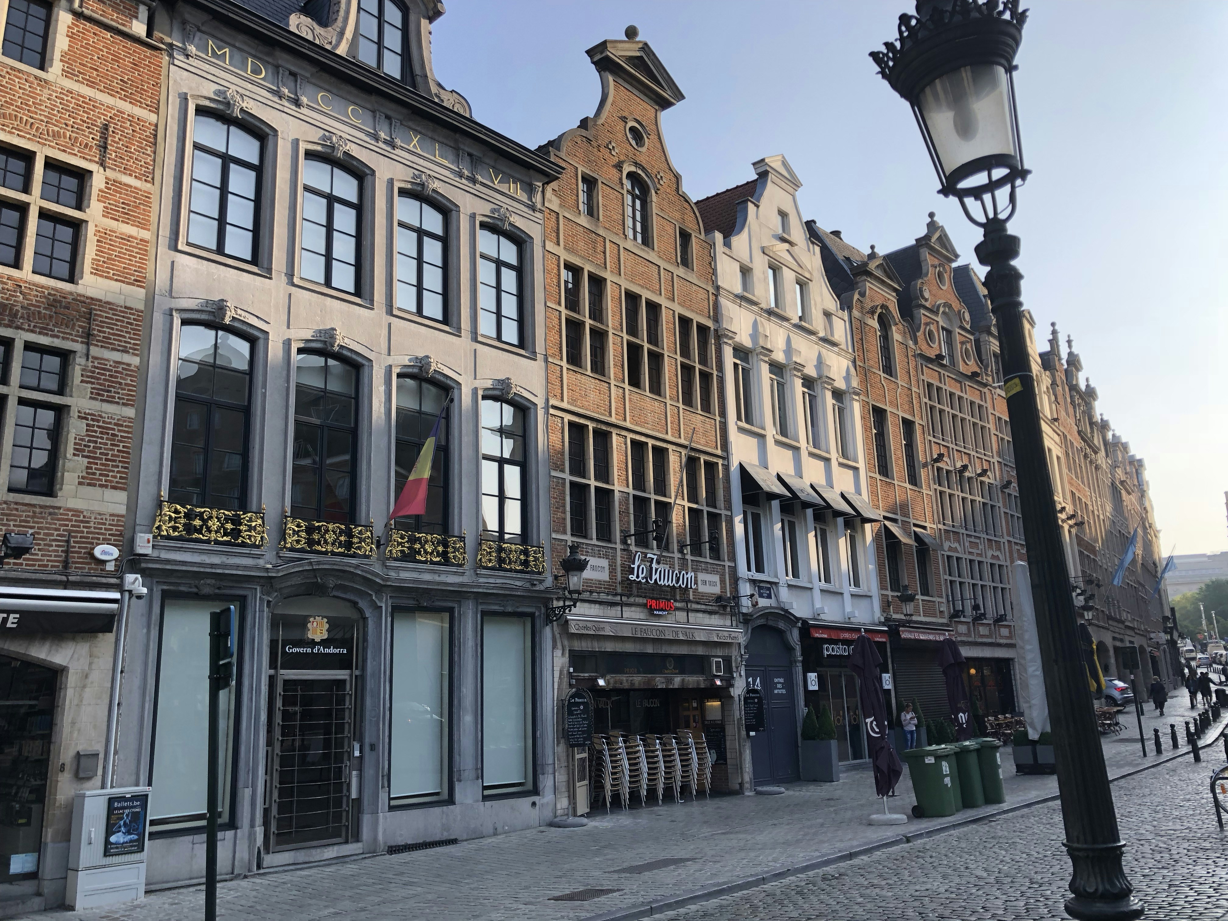 Sunlit Flemish Facades: A Cobblestone Street of Time