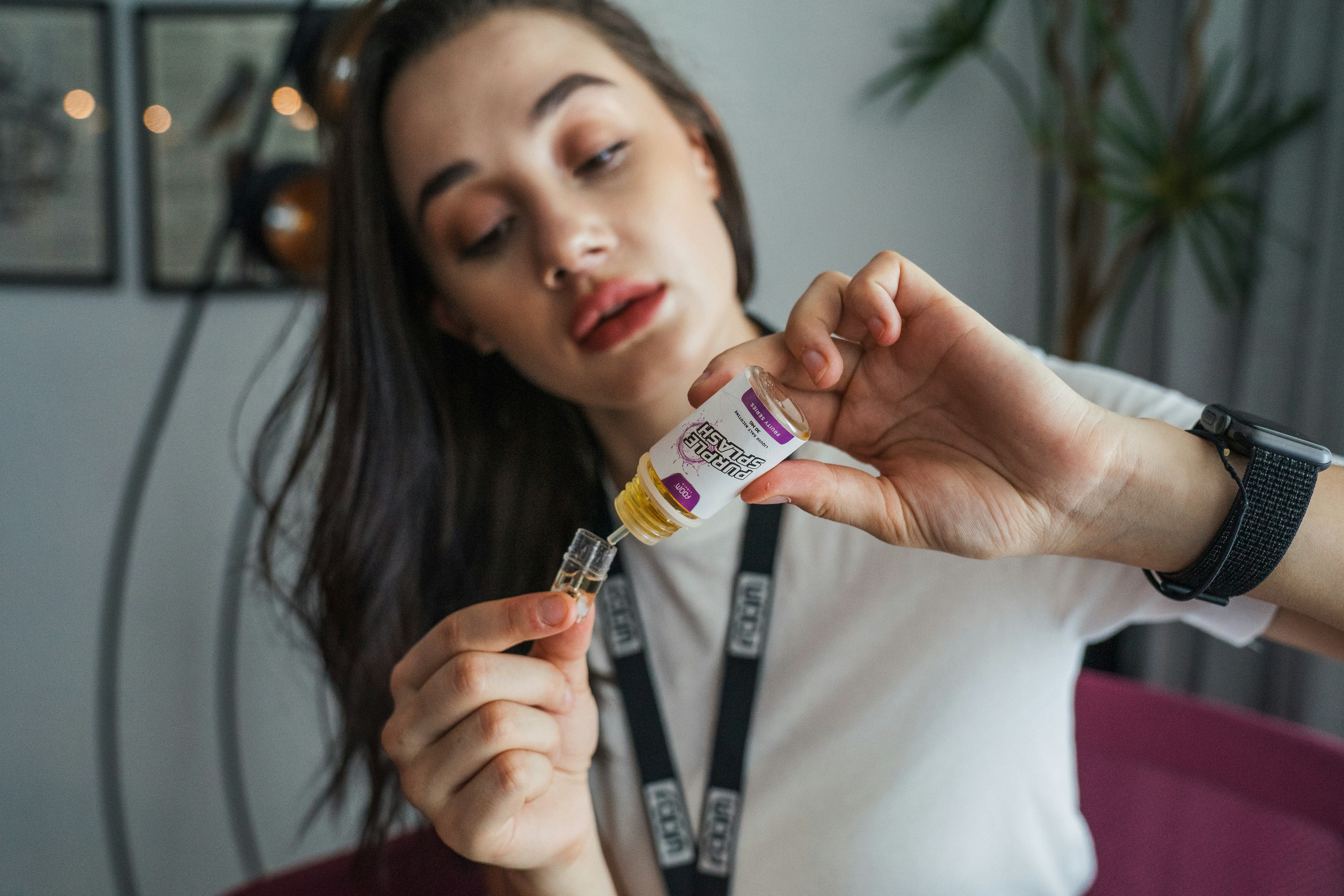 A woman holding a small bottle of medicine photo – Free Juul Image on ...