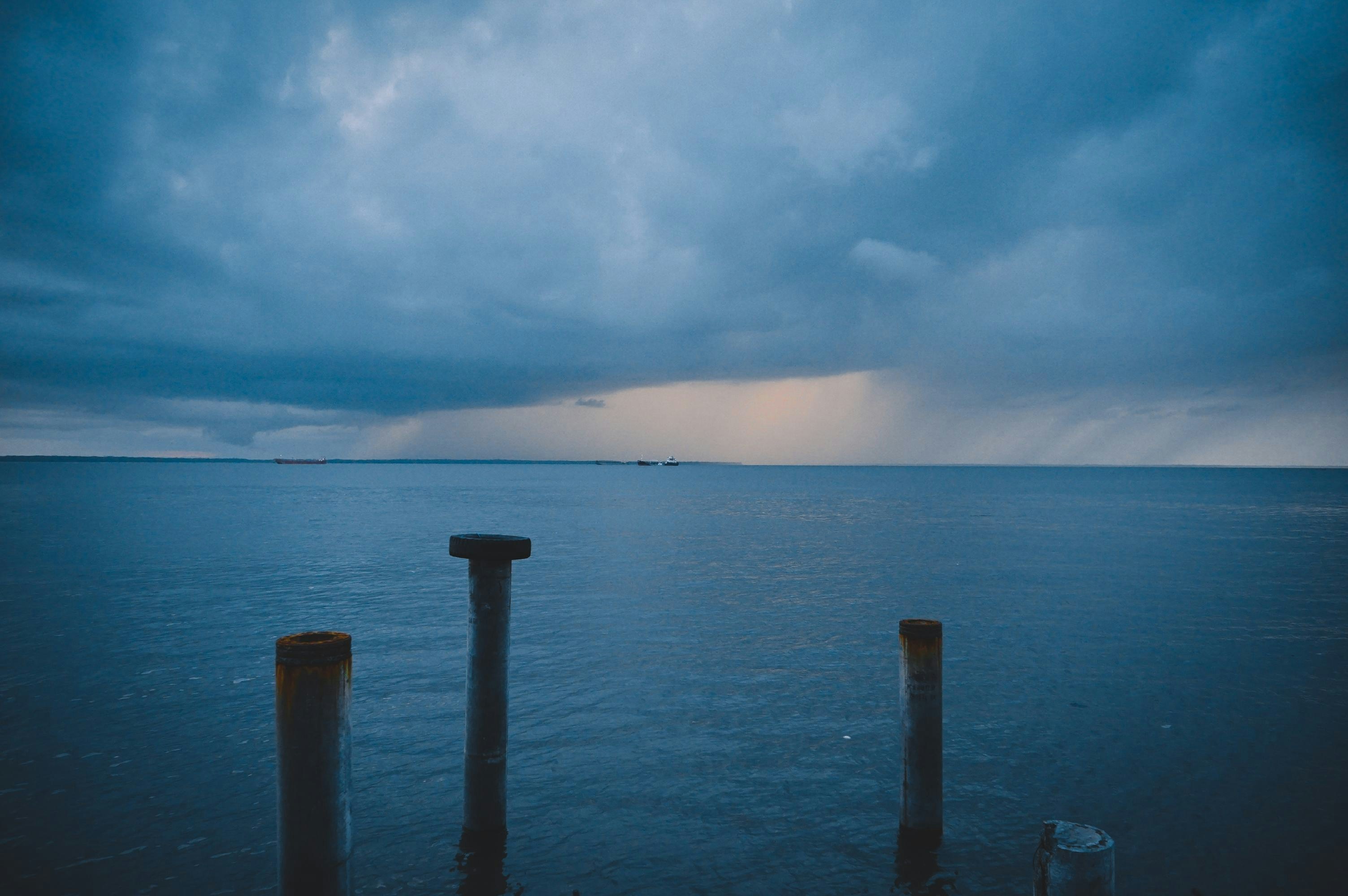 Distant Stillness: Pier Columns Reaching Toward a Storm-Burnished Horizon