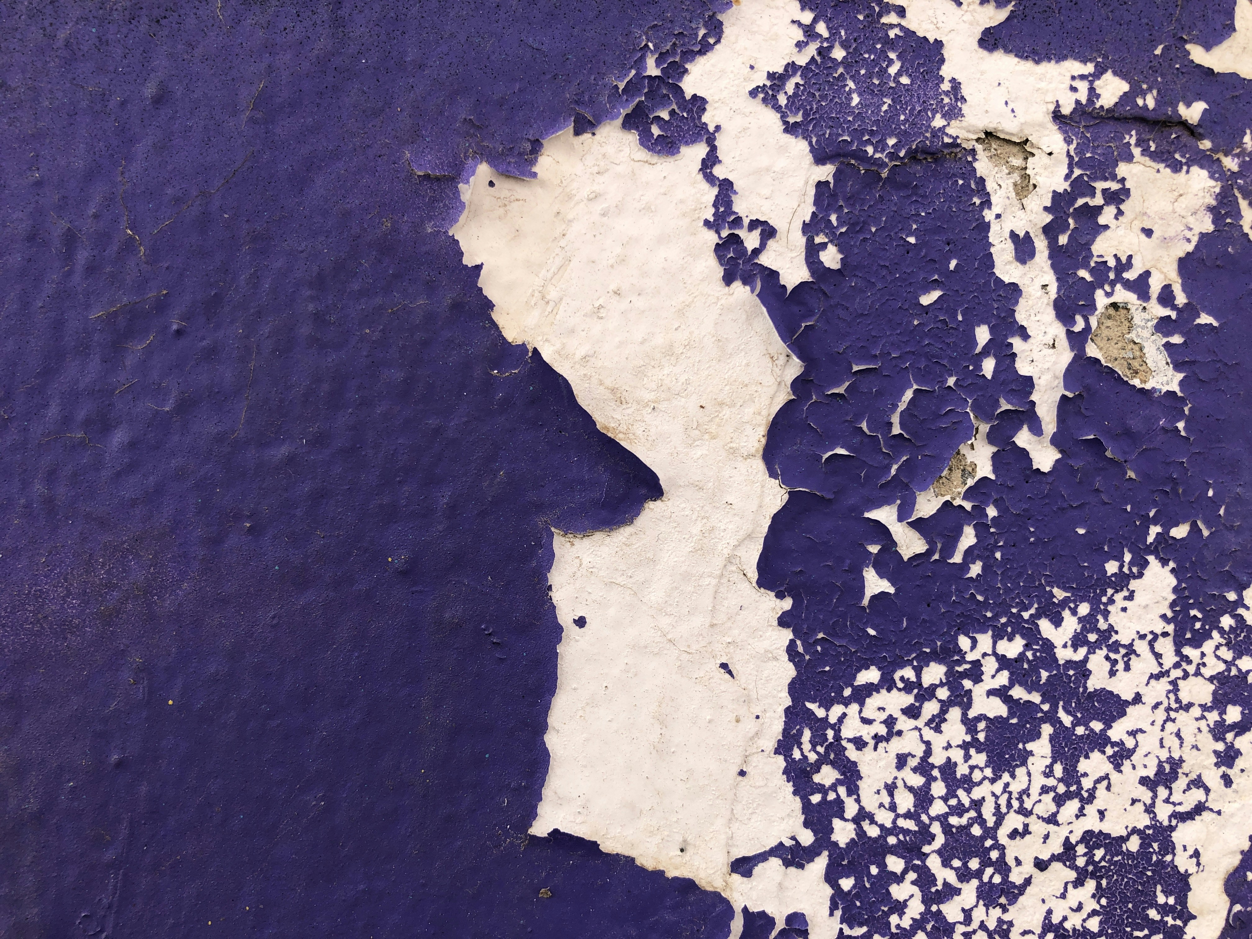 Indigo Peels Reveal a Subtle Beige Core in Weathered Wall Texture
