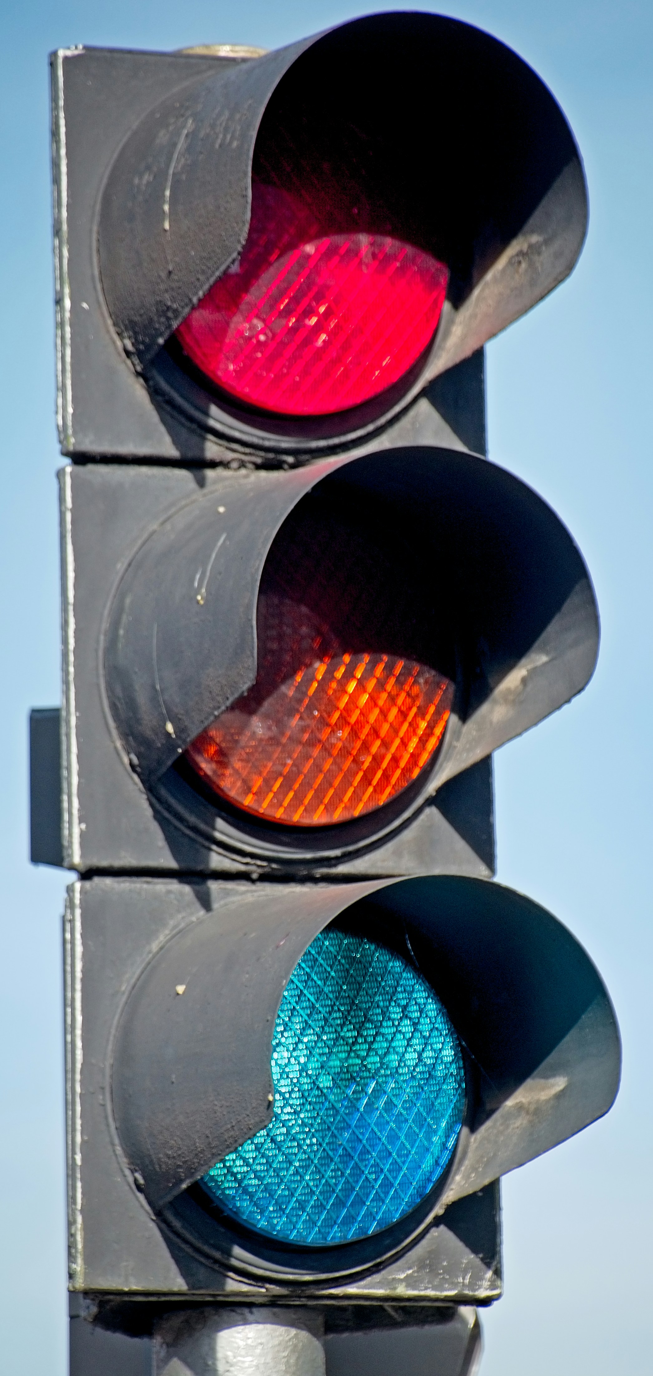 A traffic light with two red and one blue lights photo – Free Light ...