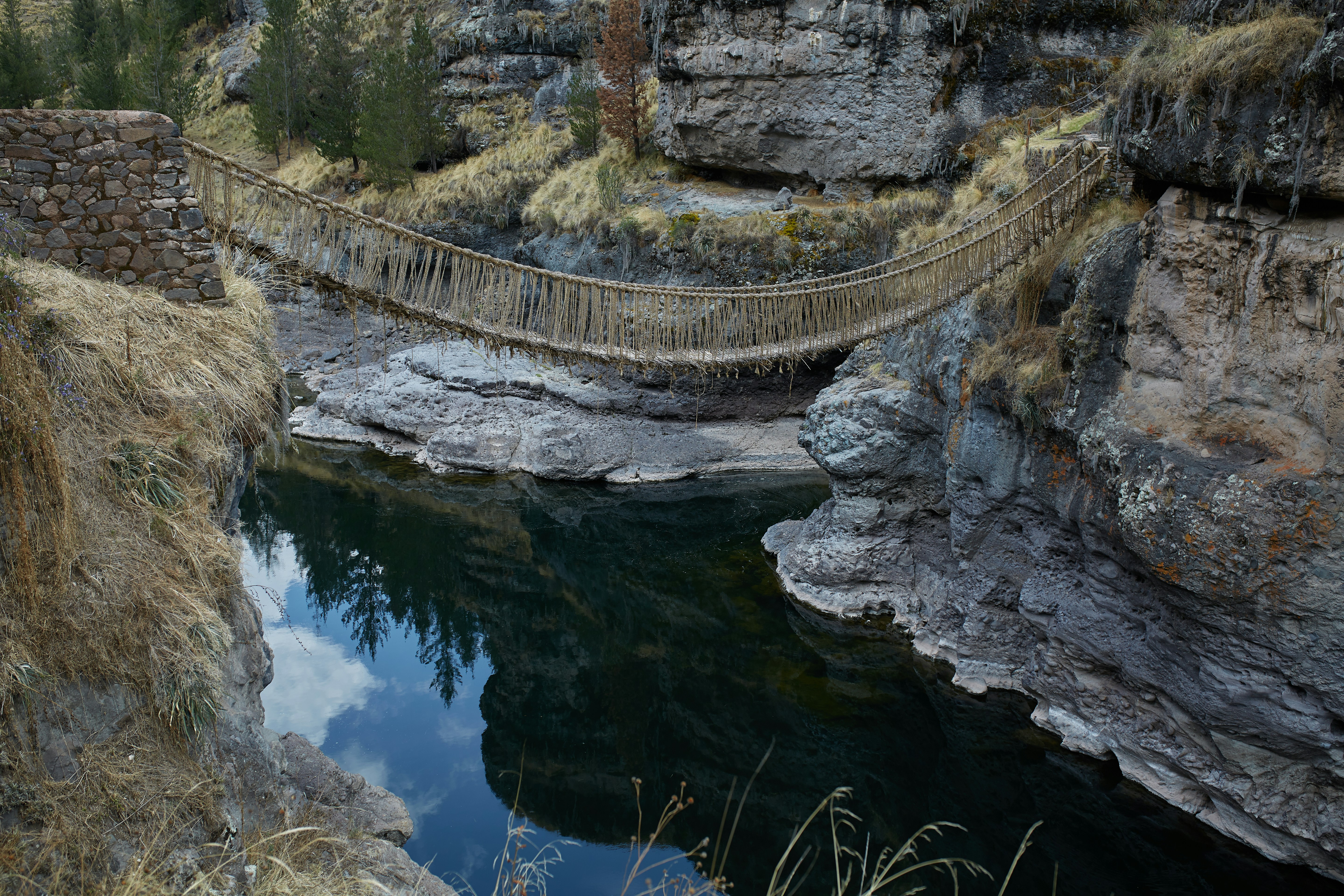 A rope bridge over a river in a canyon photo – Free Quehue Image on ...