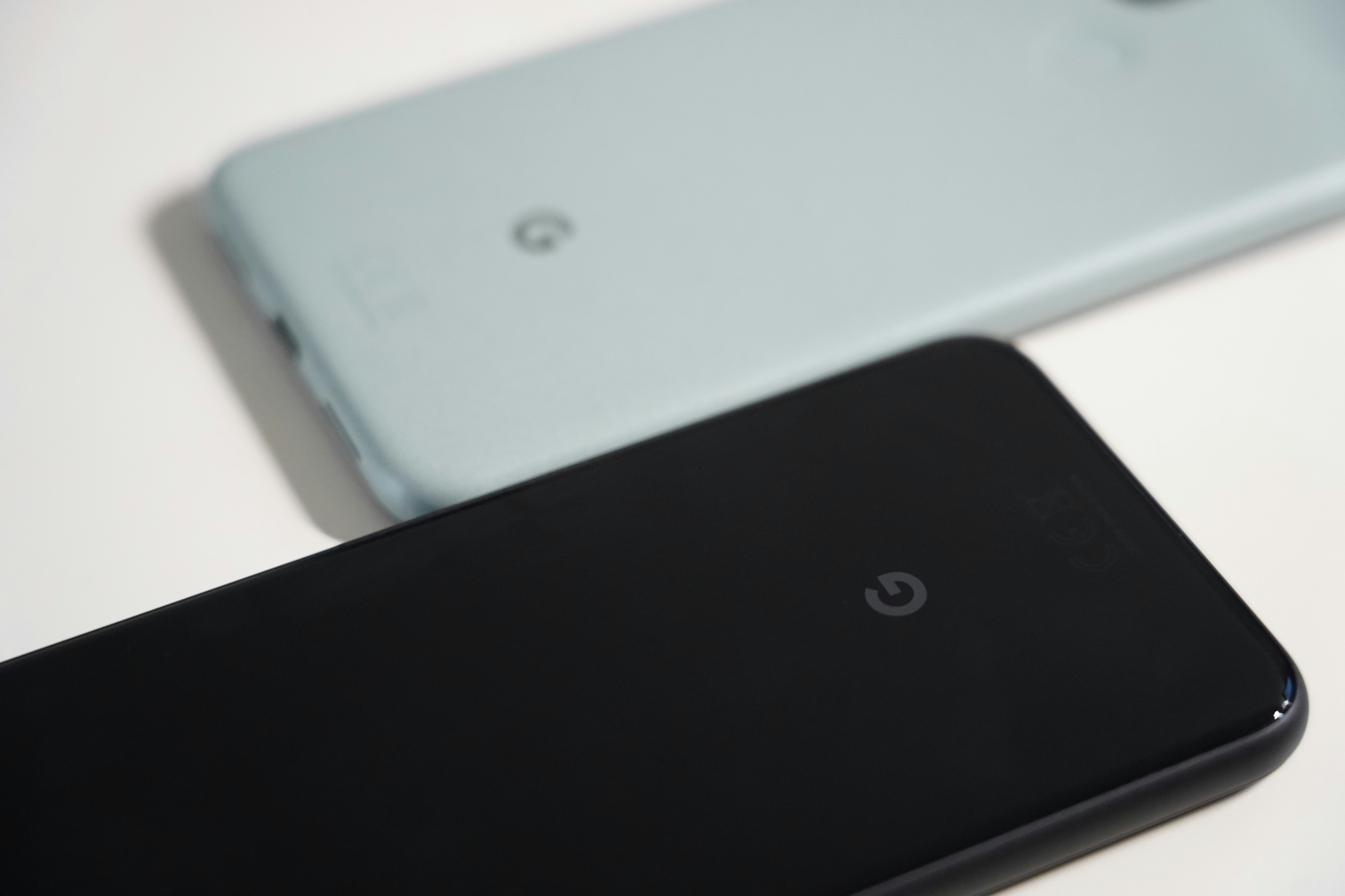 A close up of two cell phones on a table photo – Free Travel Image on ...