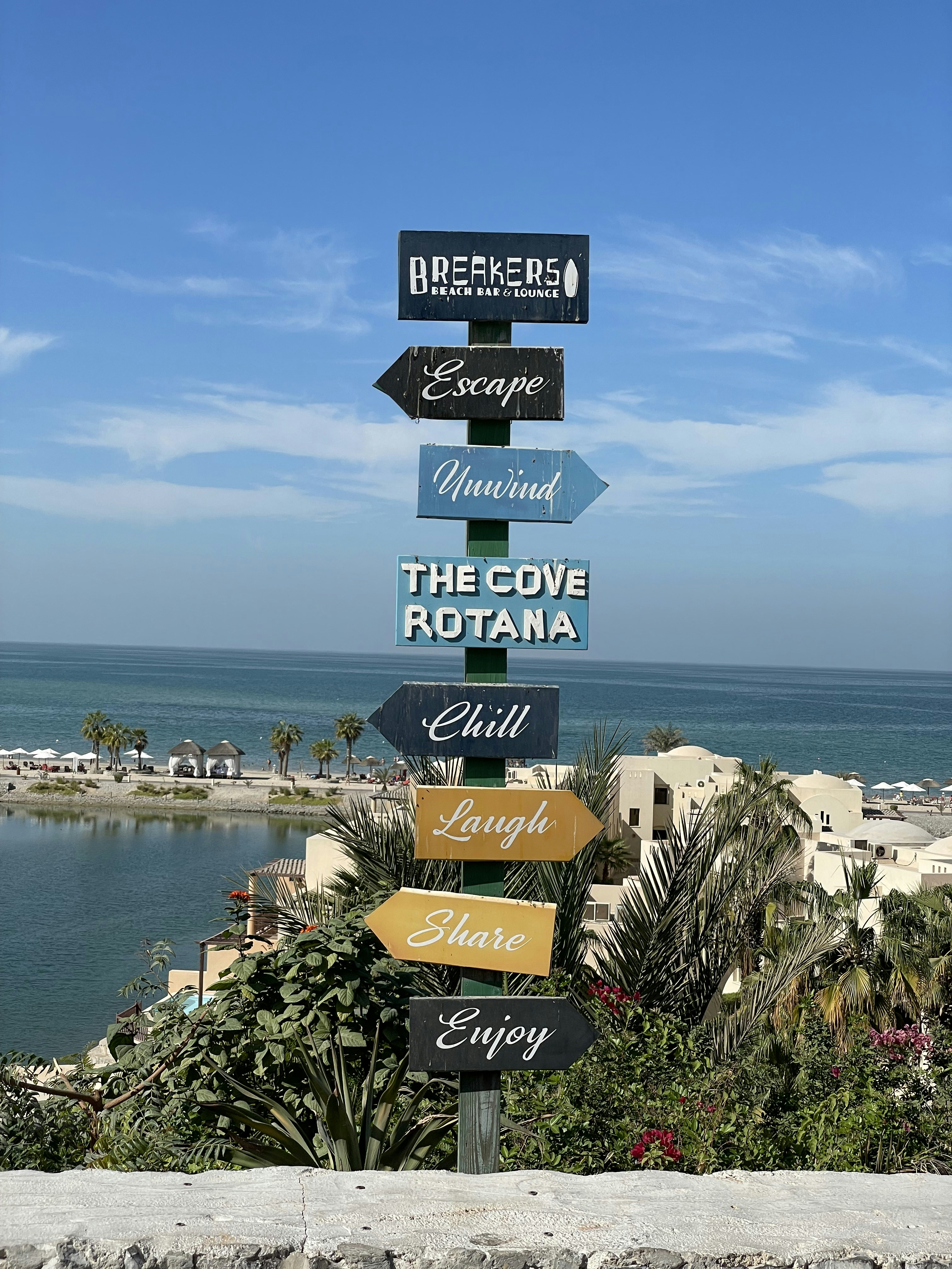 A pole with a bunch of different signs on it photo – Free Beach Image ...
