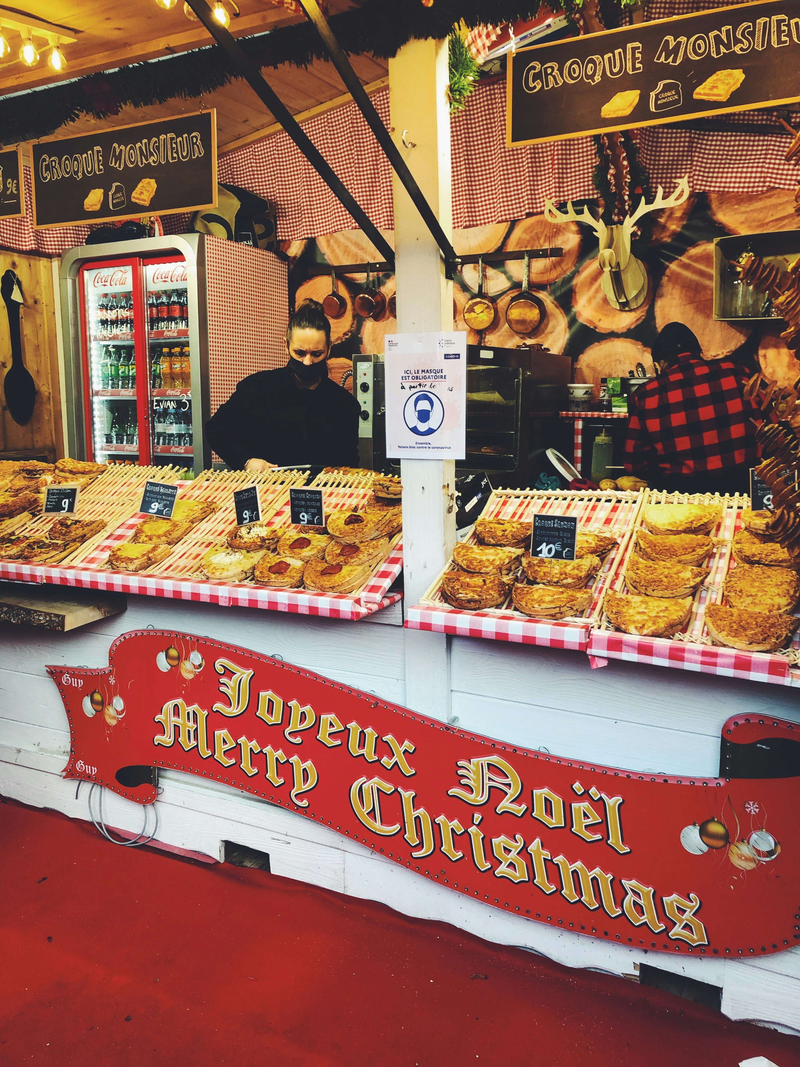 a man standing in front of a display of pastries