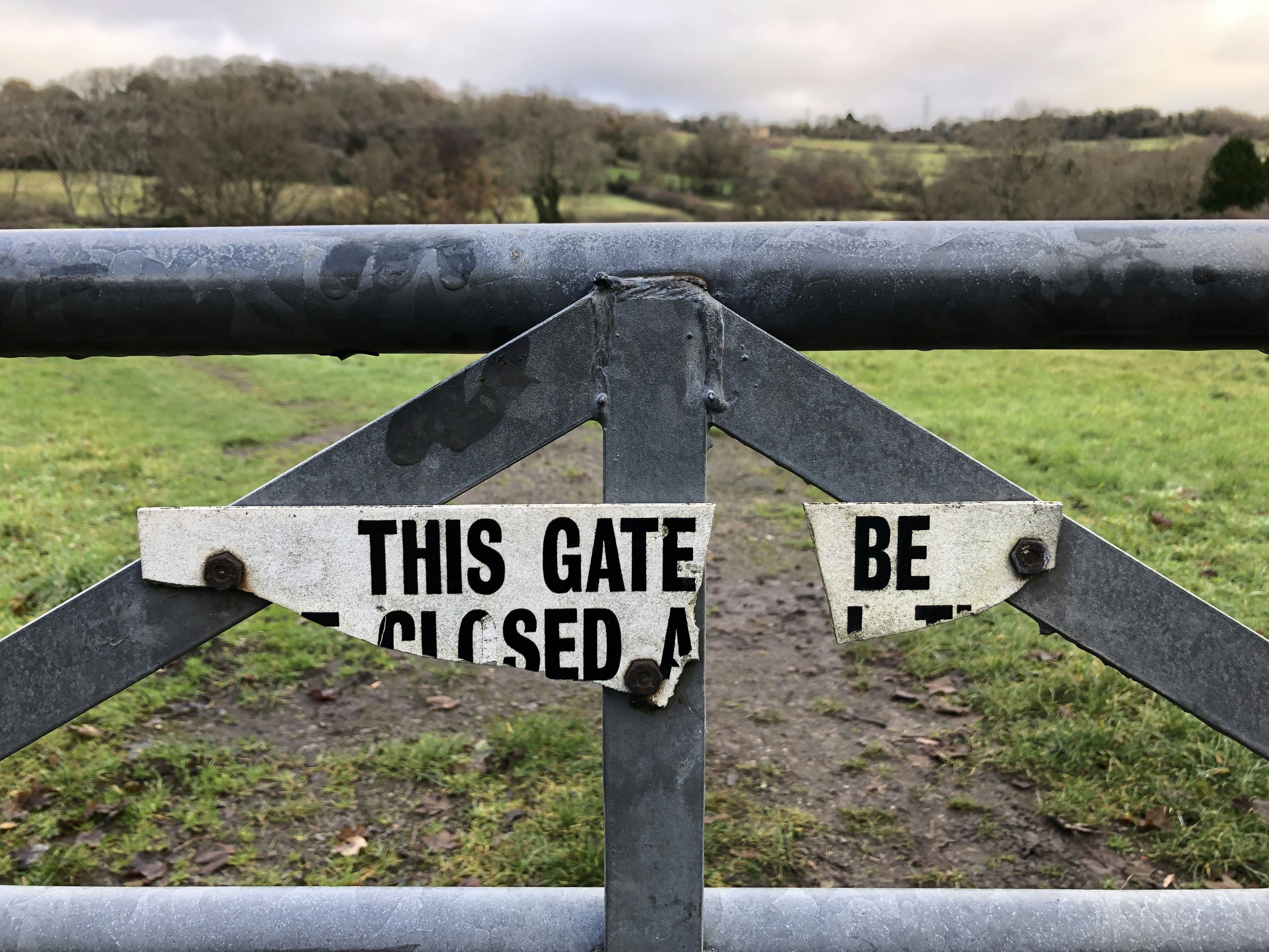 A gate with a sign that says this gate is closed photo – Free Winter ...