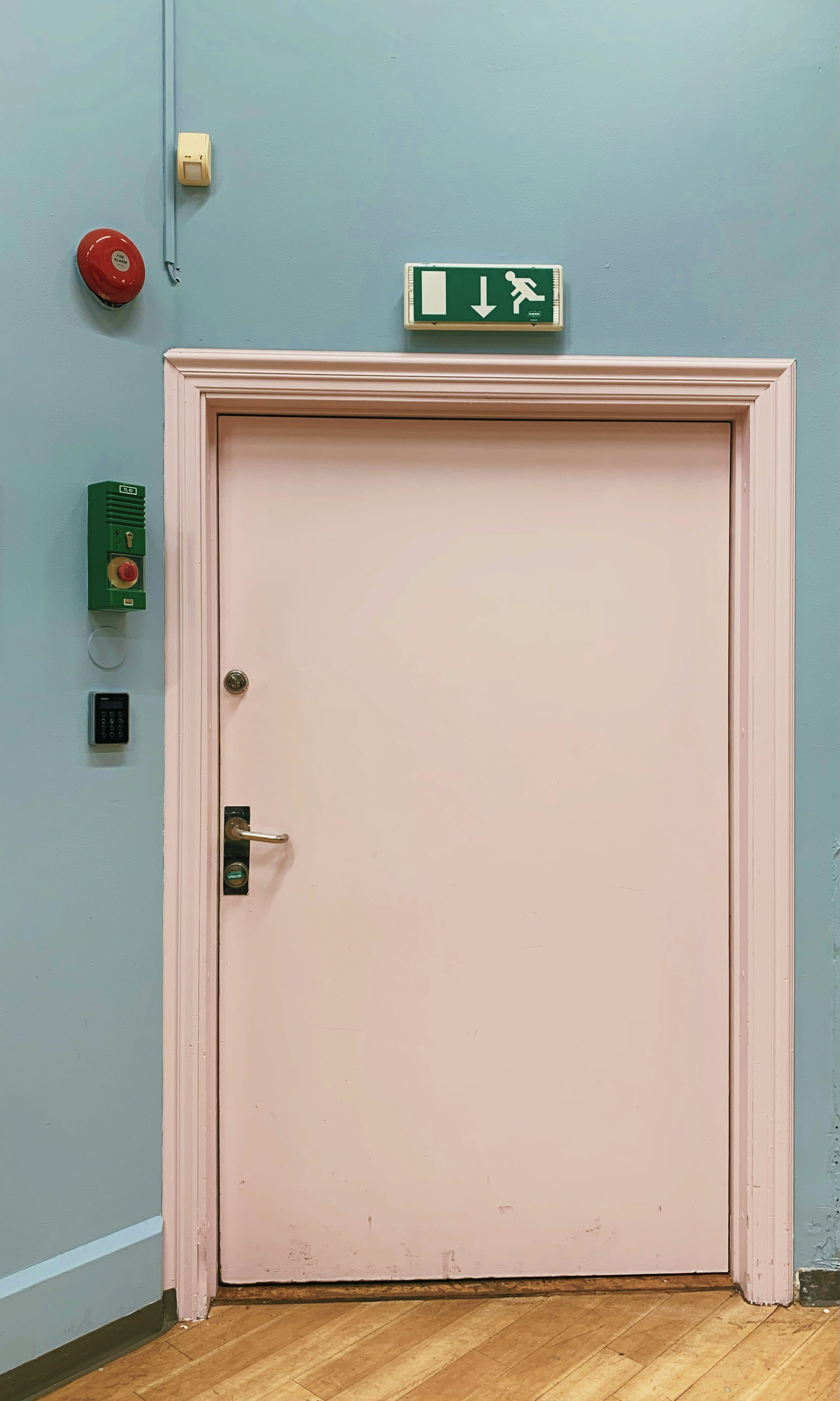 Pastel Threshold: A Quiet Doorway in a Powder-Blue Hall