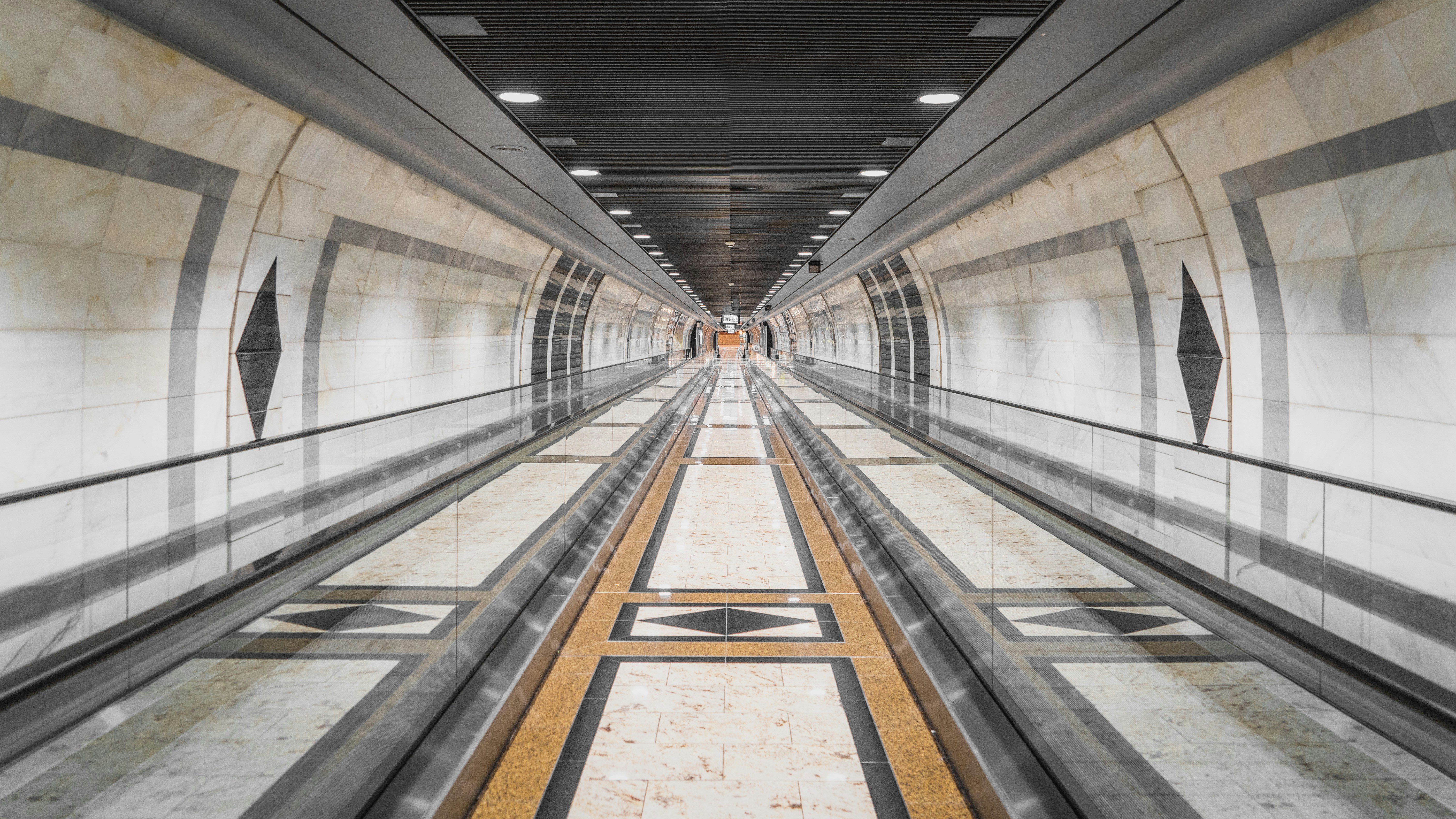 A long hallway with a long line of escalators photo – Free Monaco Image ...