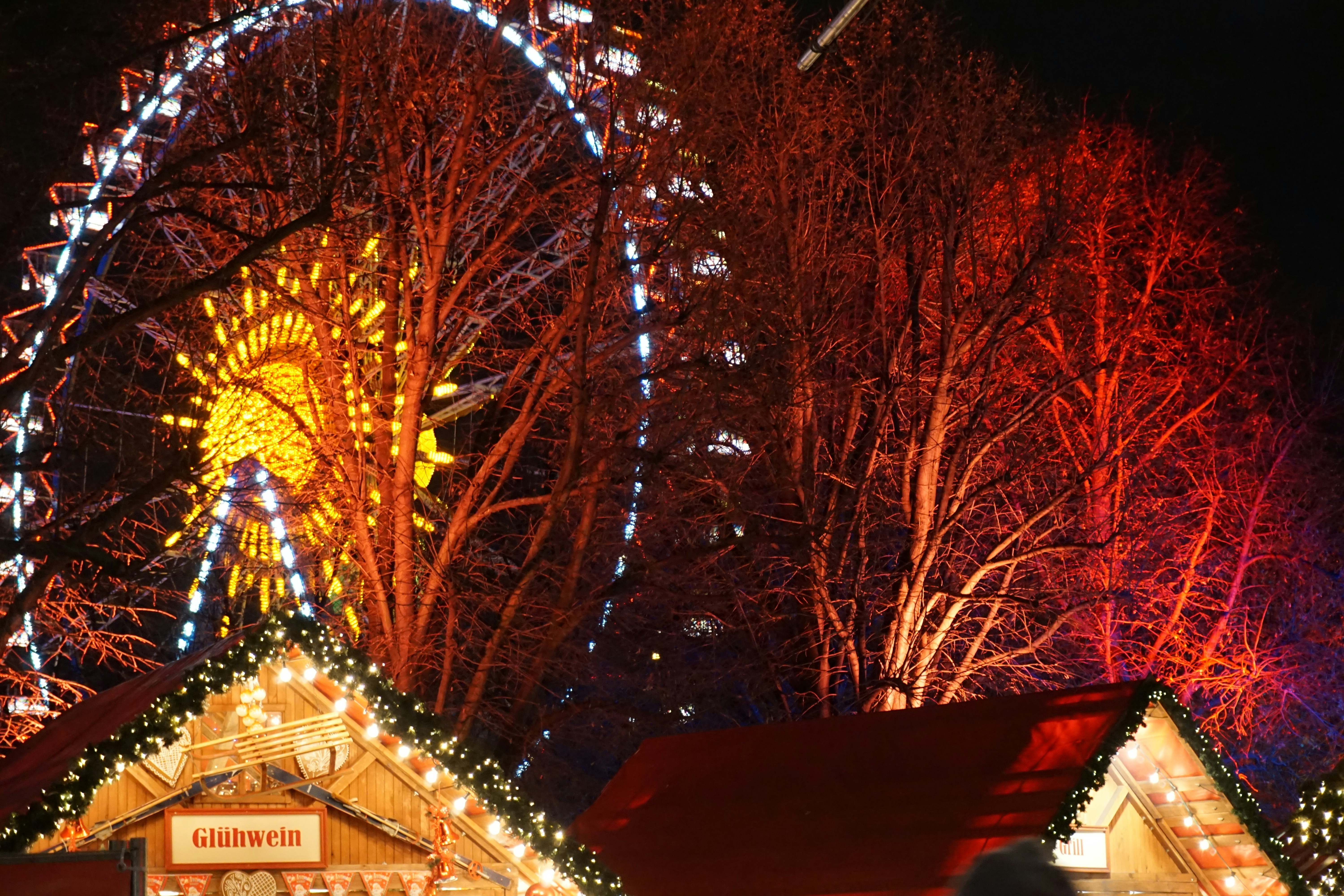 Ferris Wheel at Night: Warm Lights Over a Winter Market