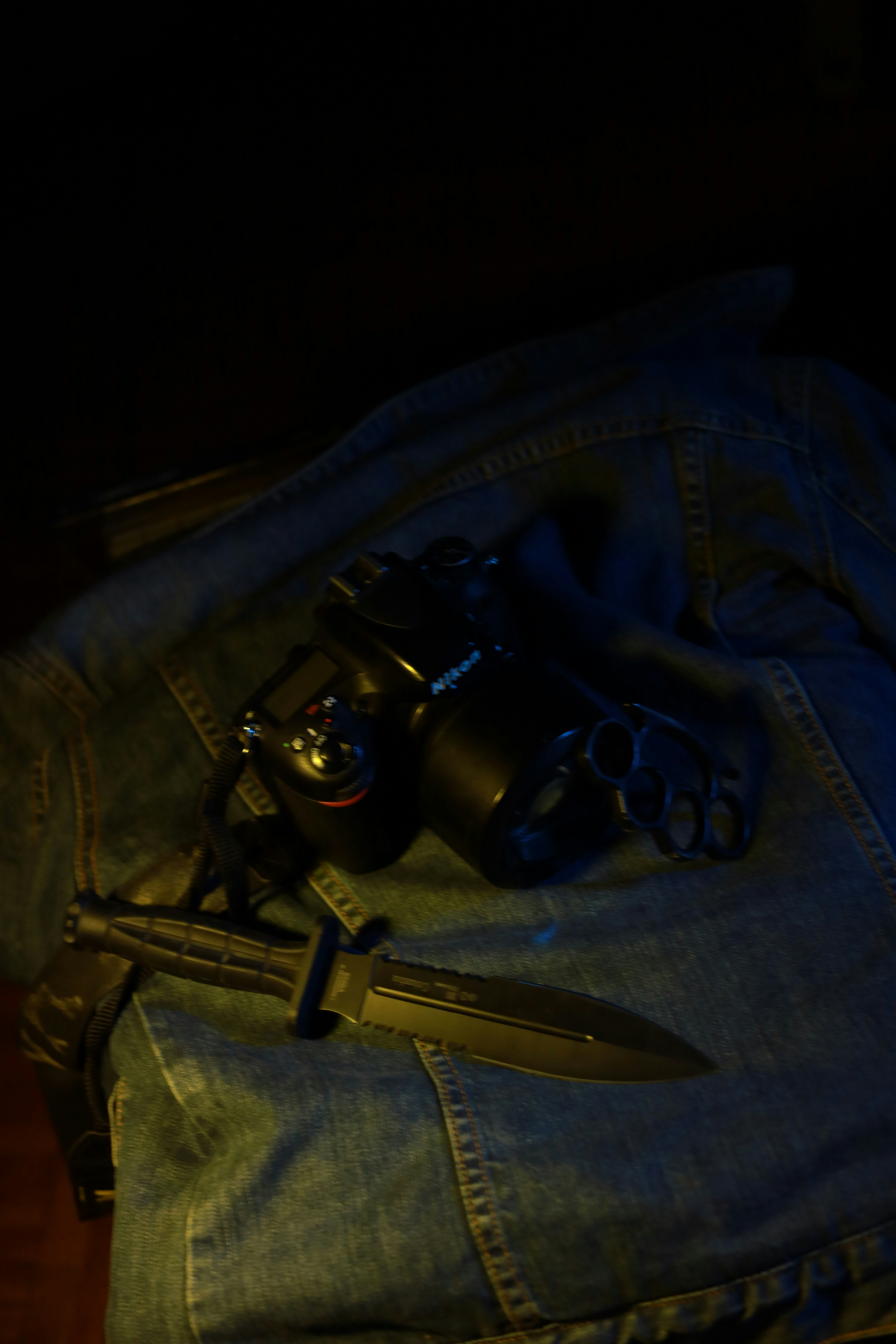 Blue Hour Still Life: A Camera and a Knife Rest on Jeans