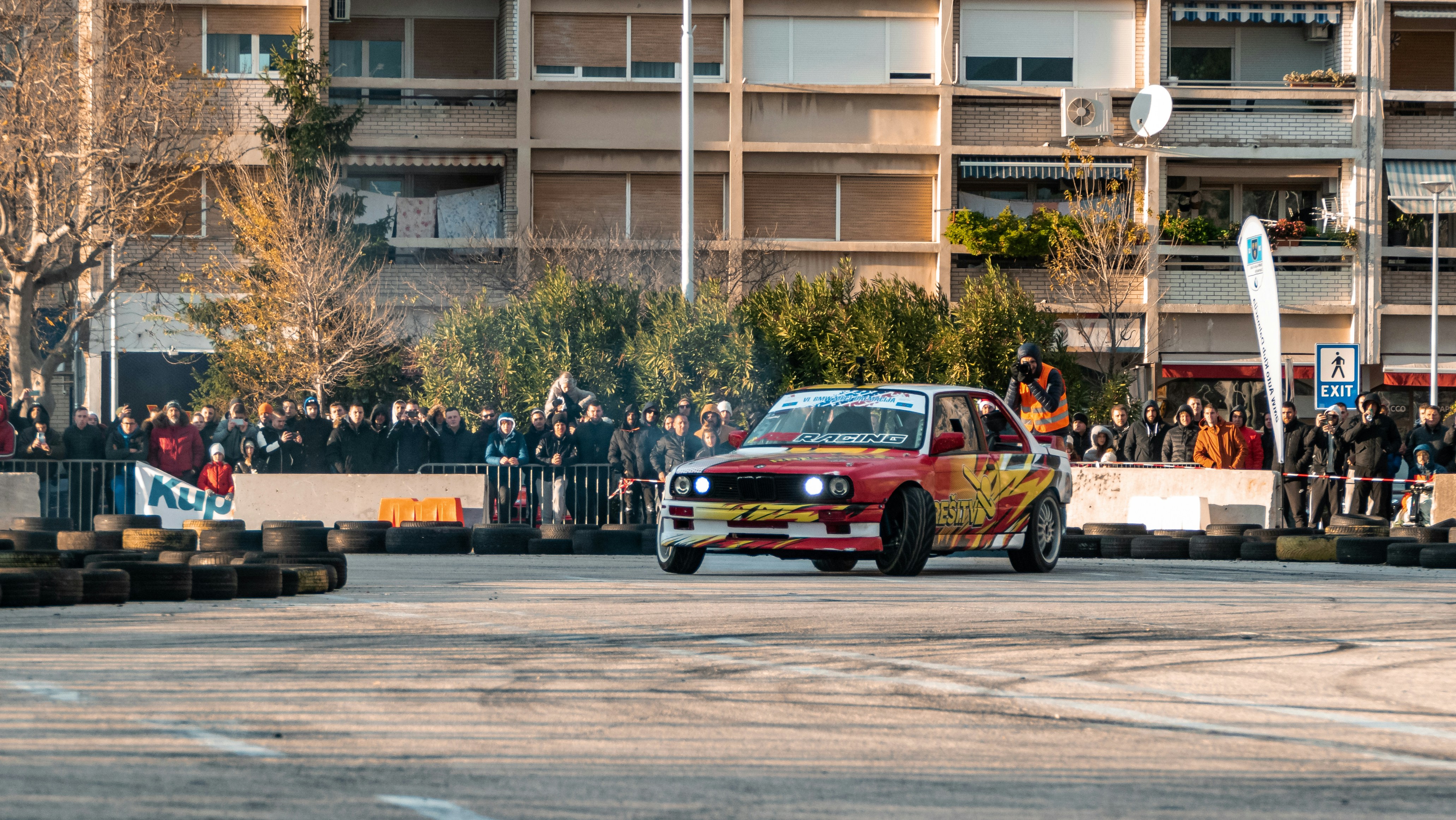 Urban Drift Chronicle: Red Rally Car Slices Through Tire Barriers Before a Crowd