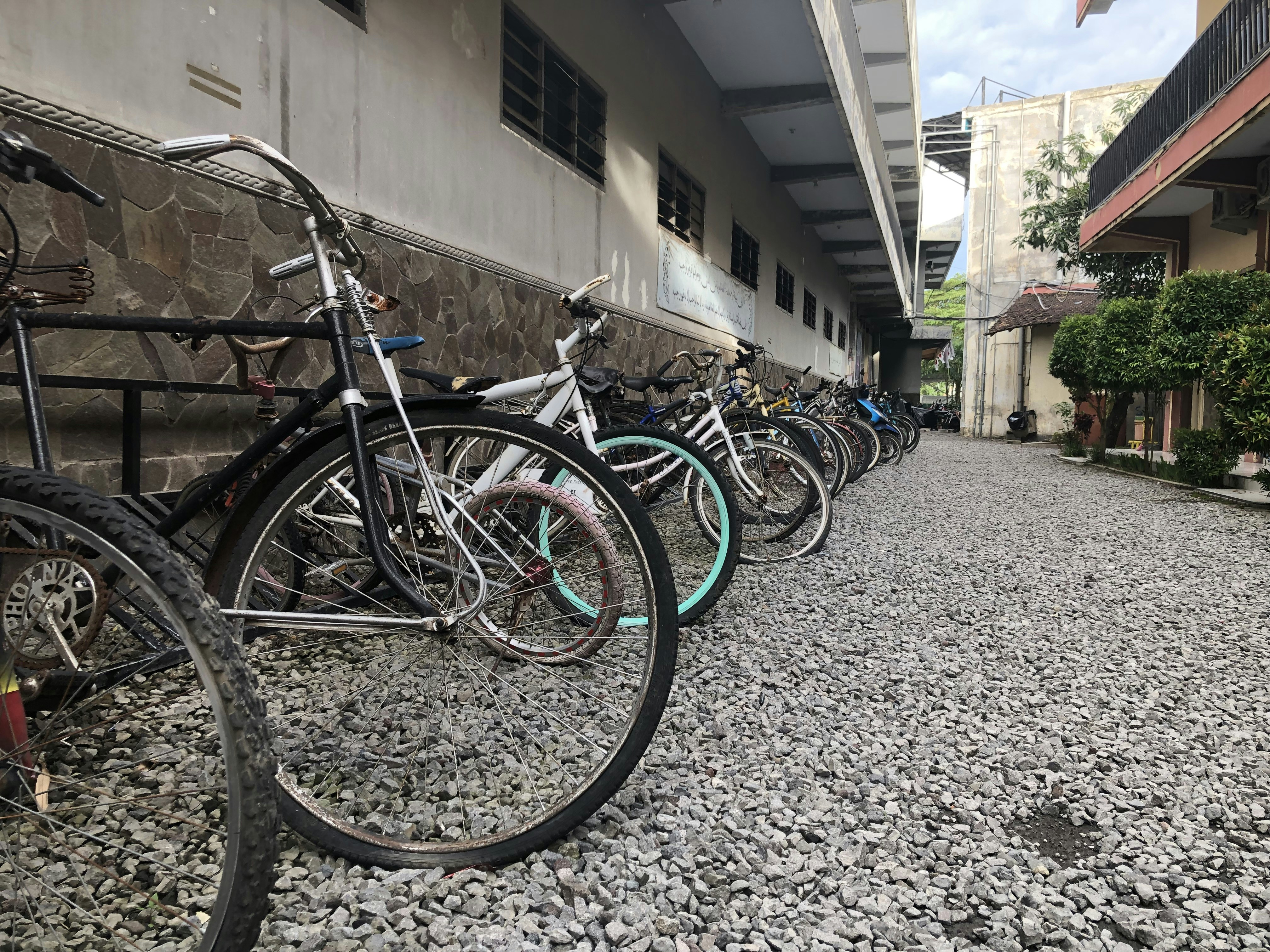 A row of bikes parked next to a building photo – Free Rocks texture ...