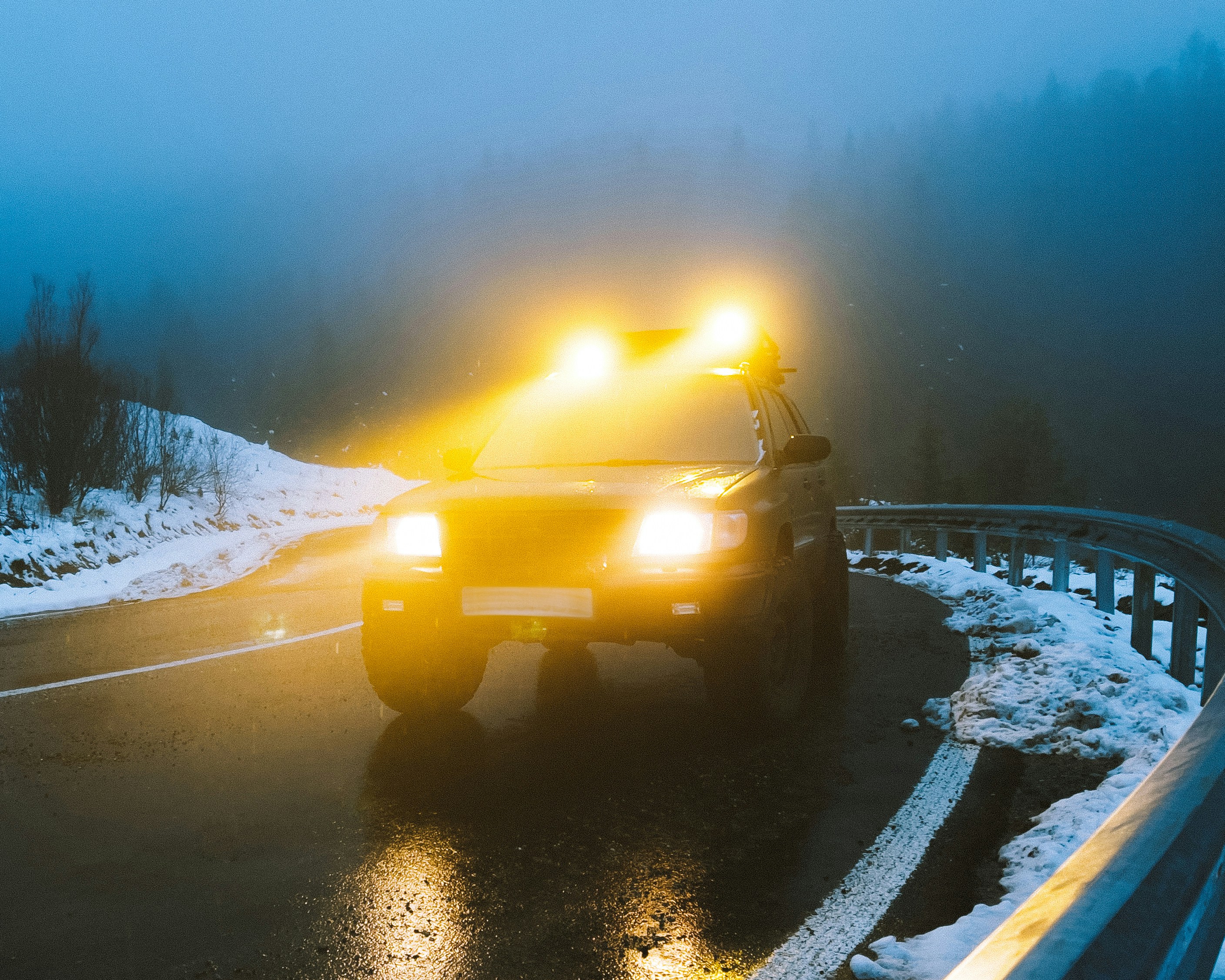 Headlights through Fog on a Snow-Slick Curve