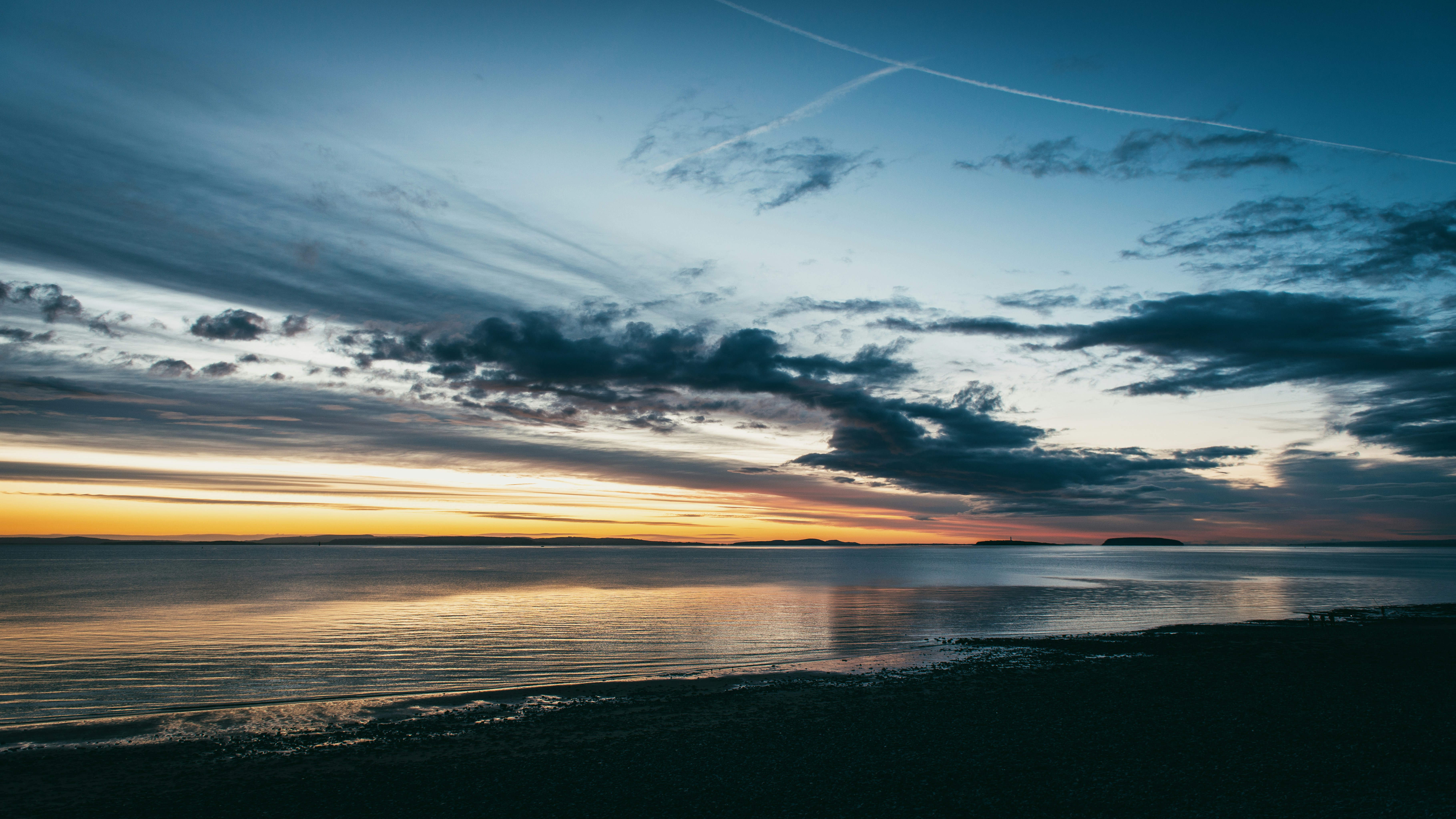 A sunset view of the ocean with clouds in the sky photo – Free Beach ...