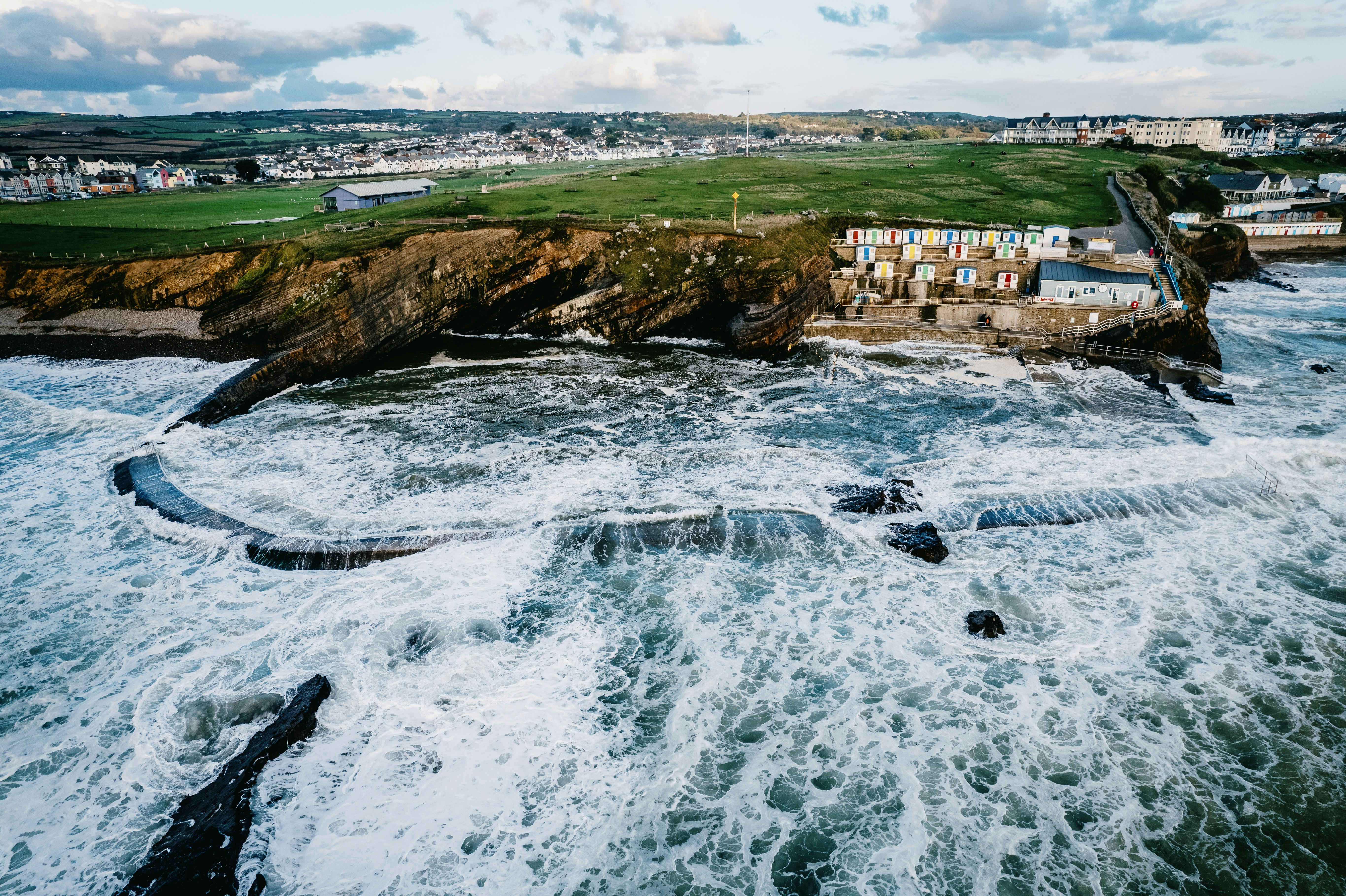 Curved Breakers and Cliffside Cottages: Aerial View of a North Atlantic Coastline