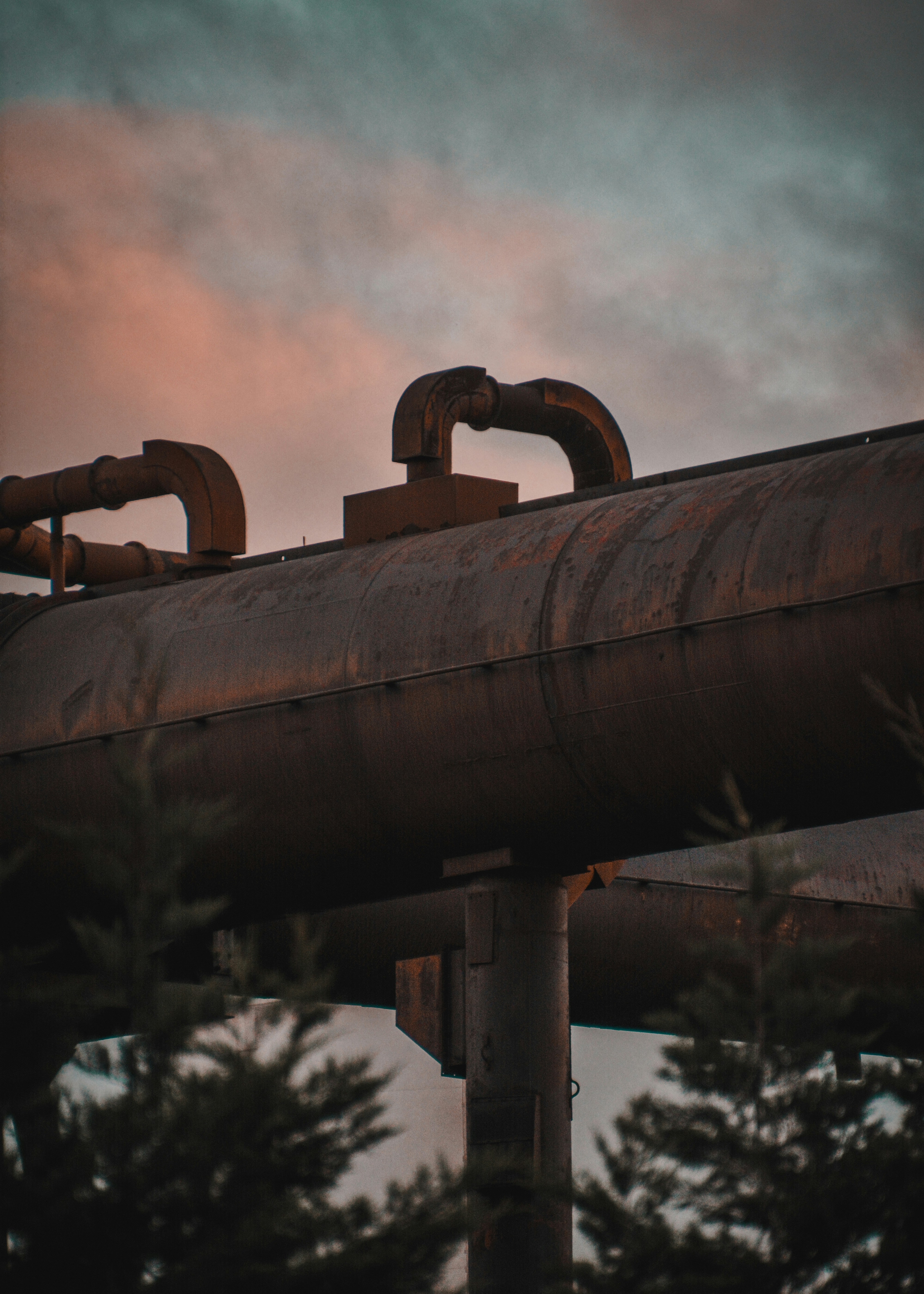 A large pipe sitting on top of a metal pipe photo – Free ...