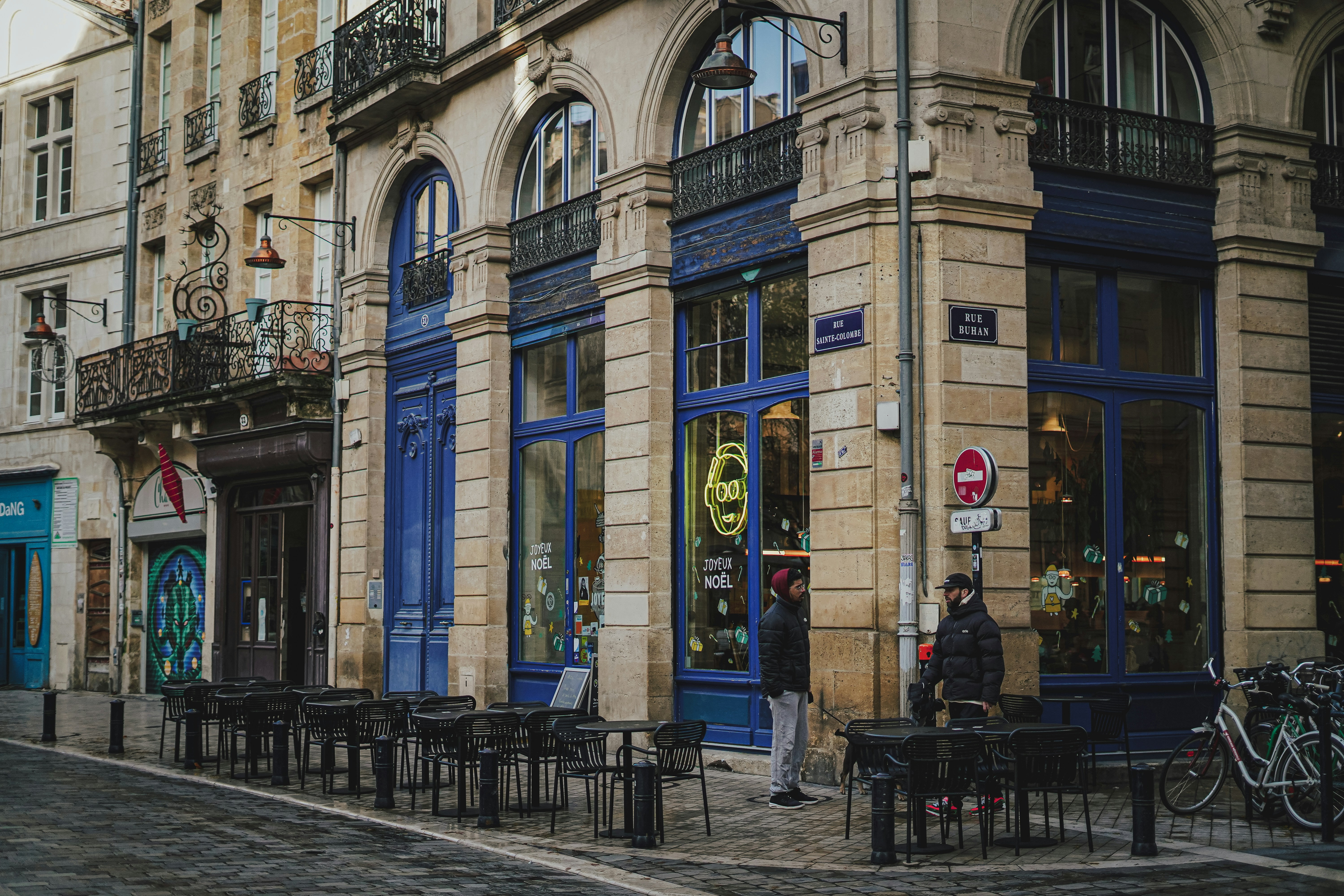 Historic building with blue-framed windows in a European city street.
