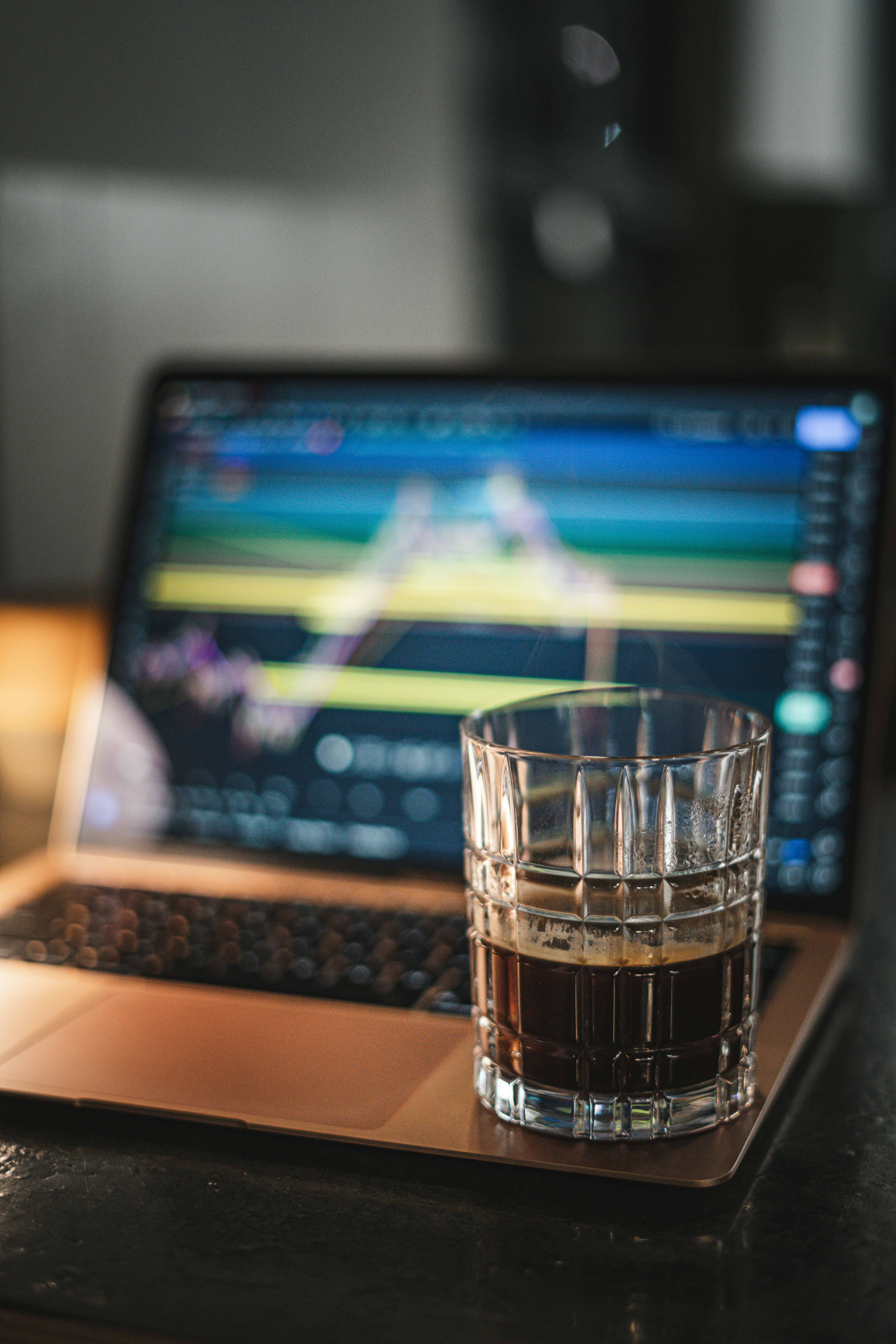 A glass of whiskey sitting on a desk next to a laptop photo – Free ...
