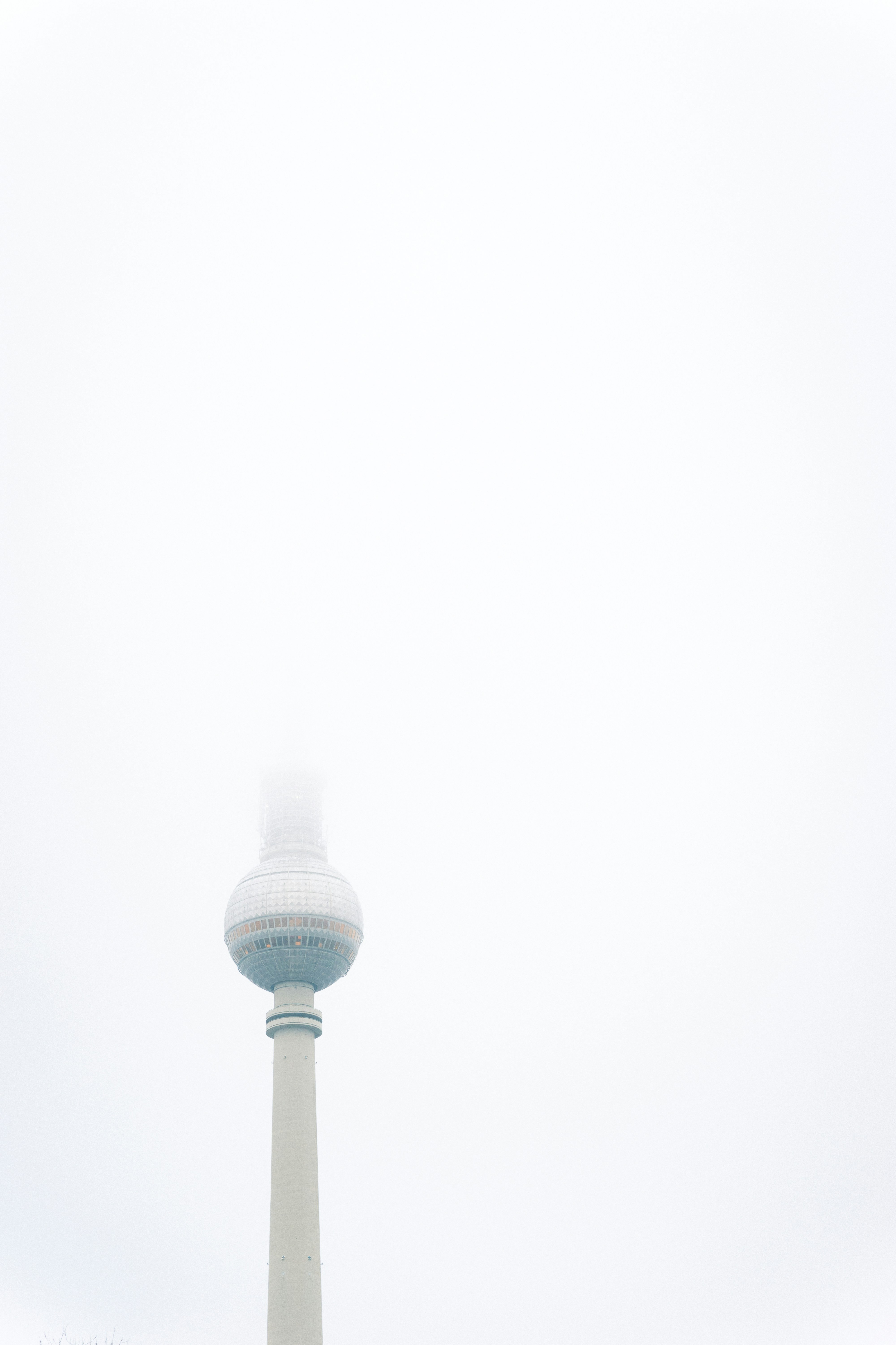 Fogbound Fernsehturm: a lone beacon dissolving into mist
