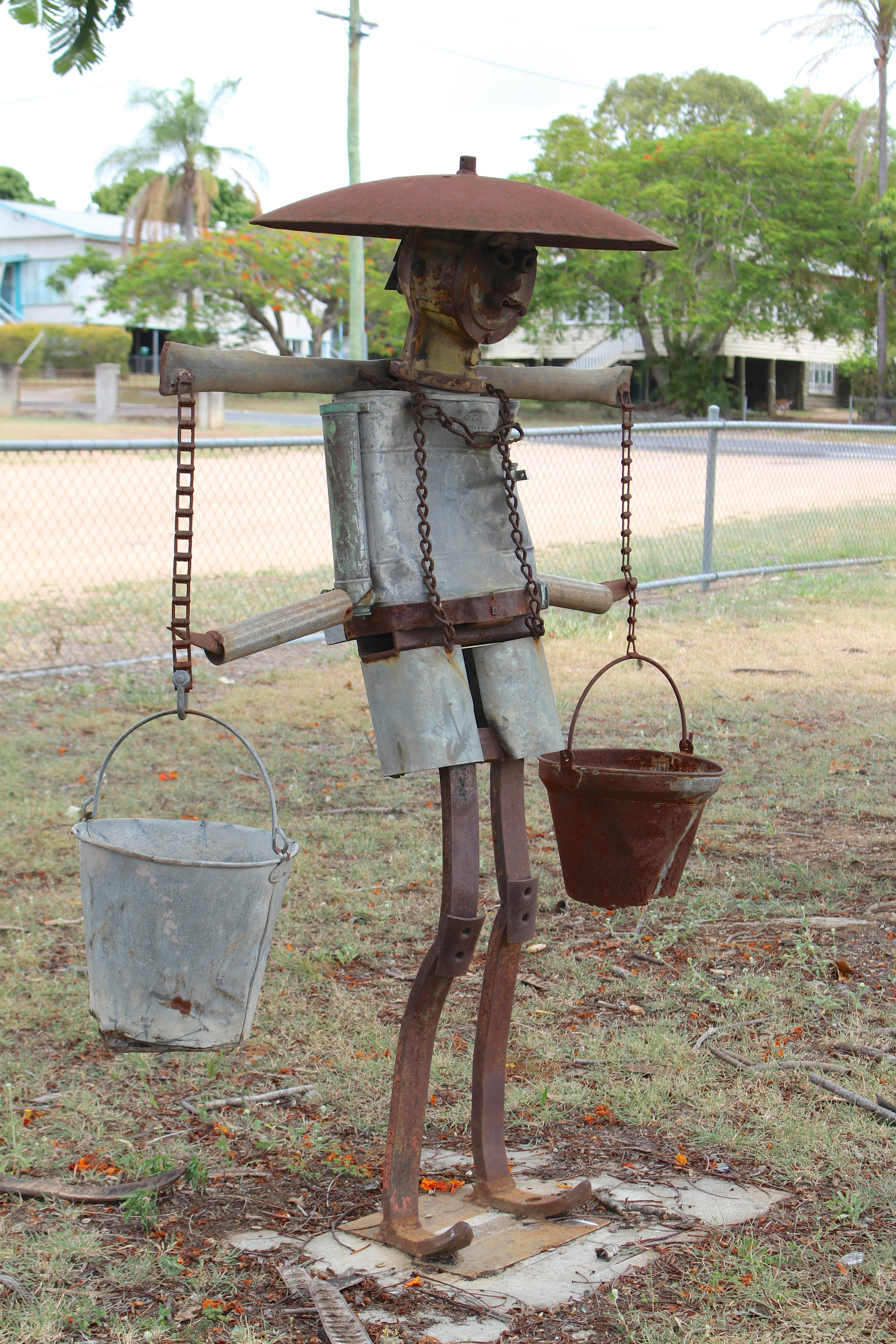 A statue of a man holding a bucket and a bucket photo – Free Gayndah ...