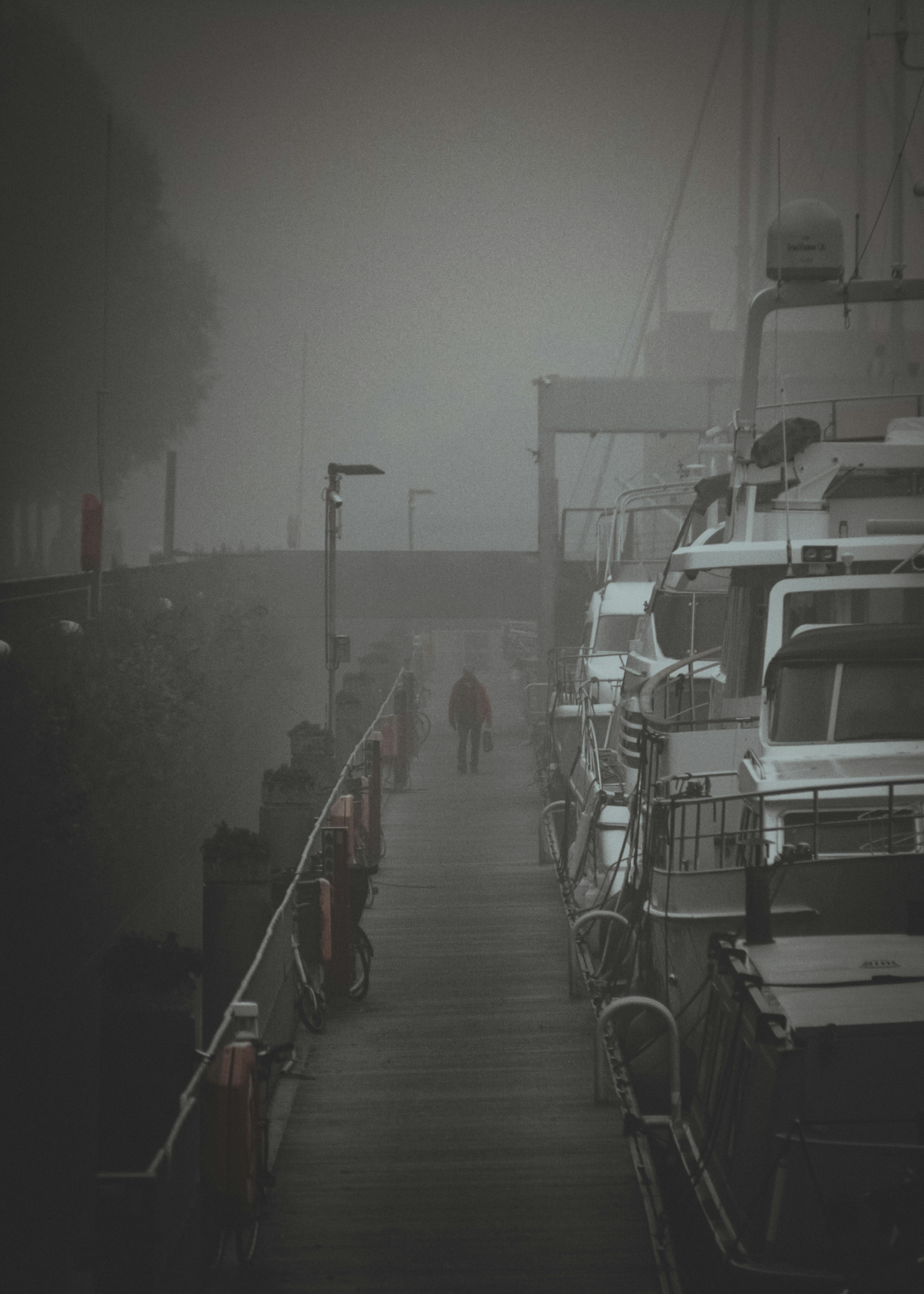 Mist-Laced Marina: A Lone Figure Walks the Foggy Dock