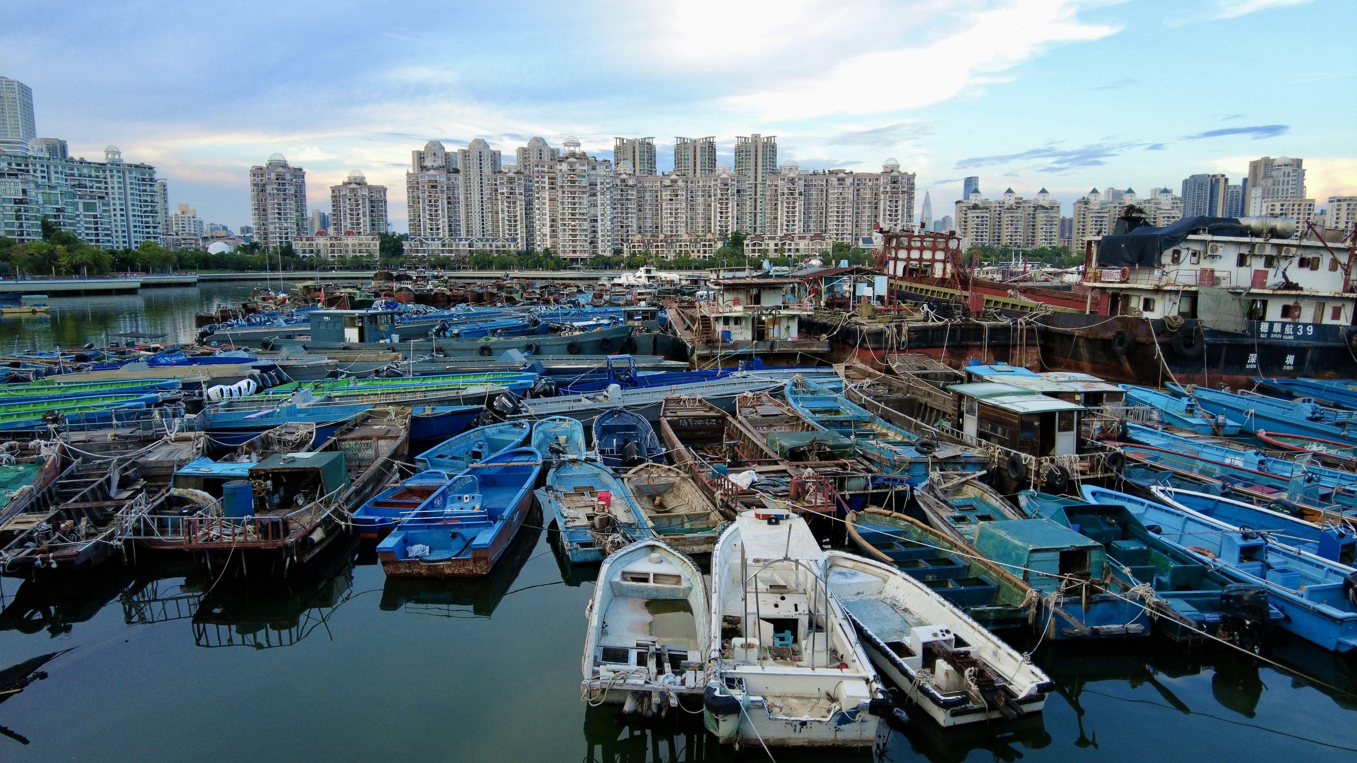 Un puerto lleno de muchos barcos junto a edificios altos foto – Imagen ...