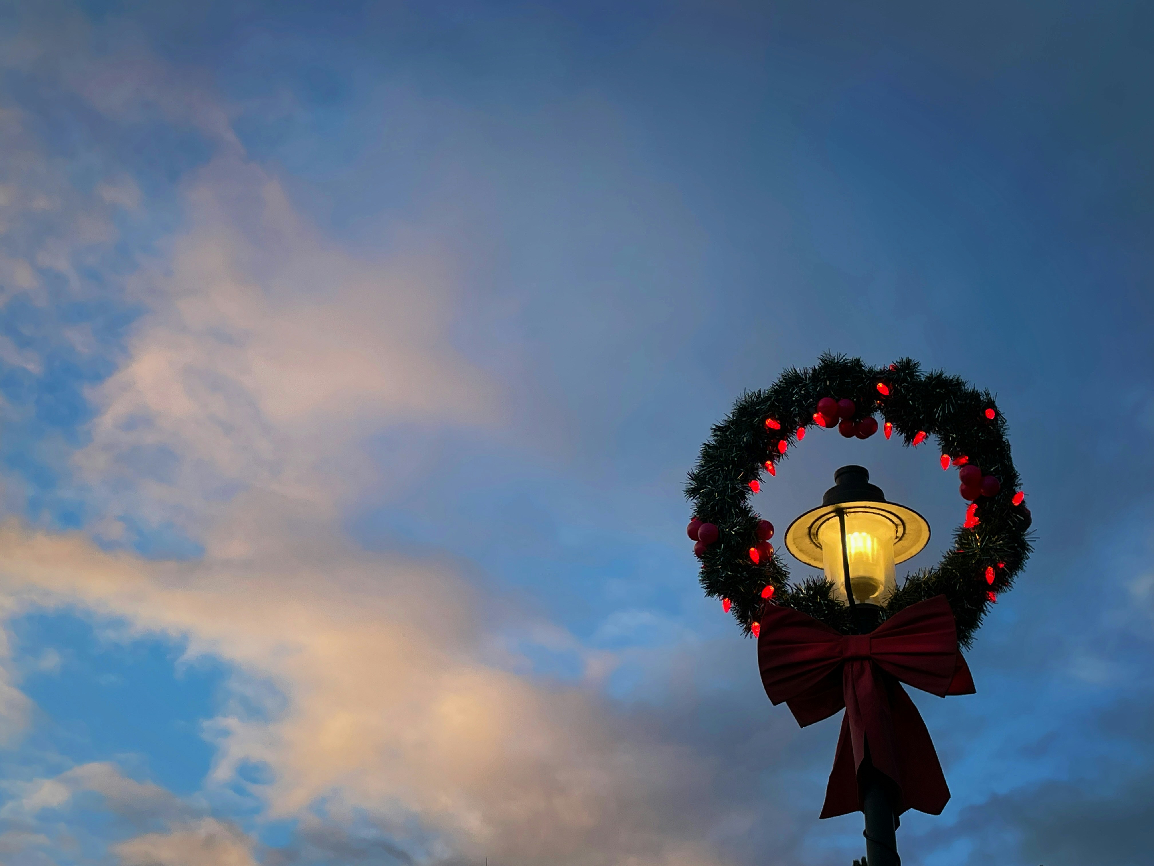 a street light with a wreath on top of it