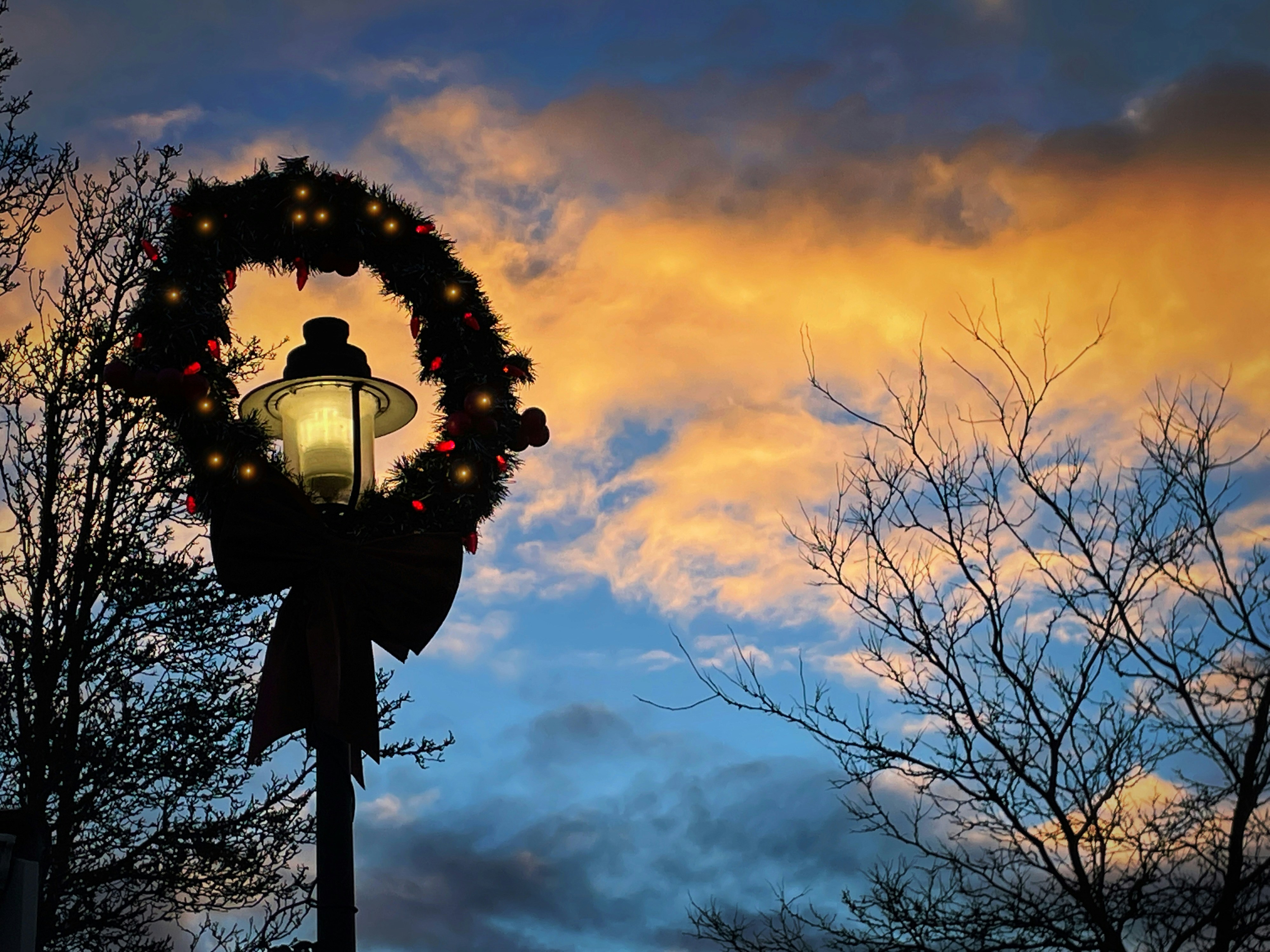 Moonlit wreath: a festive lantern against sunset