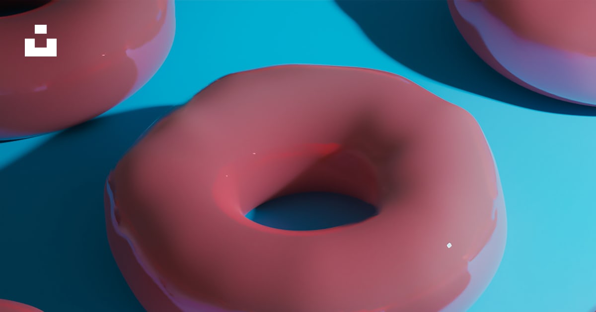 파란색 표면 위에 앉아있는 도넛 그룹 사진 Unsplash의 무료 3d 이미지