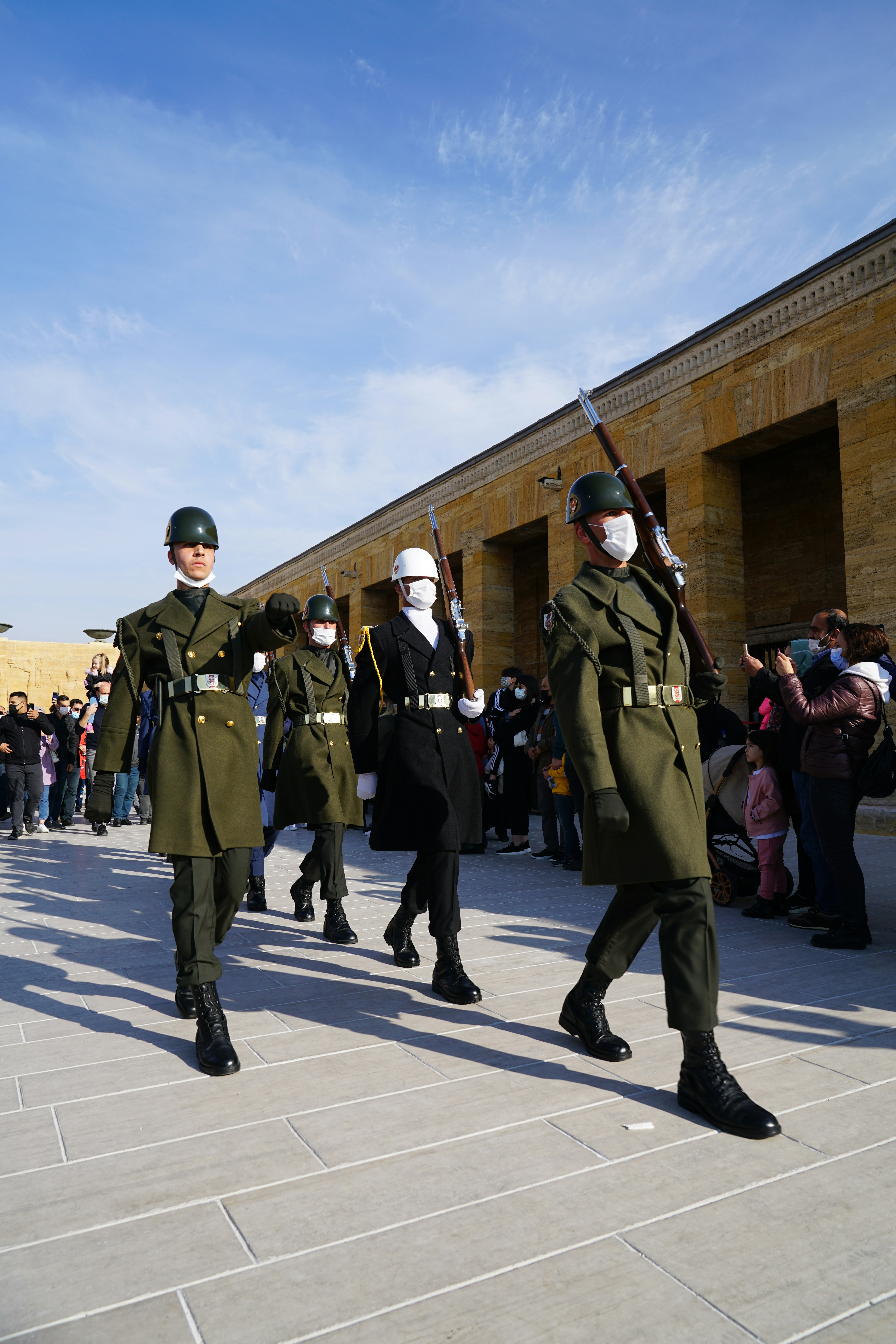 A group of men in military uniforms walking down a street photo – Free ...