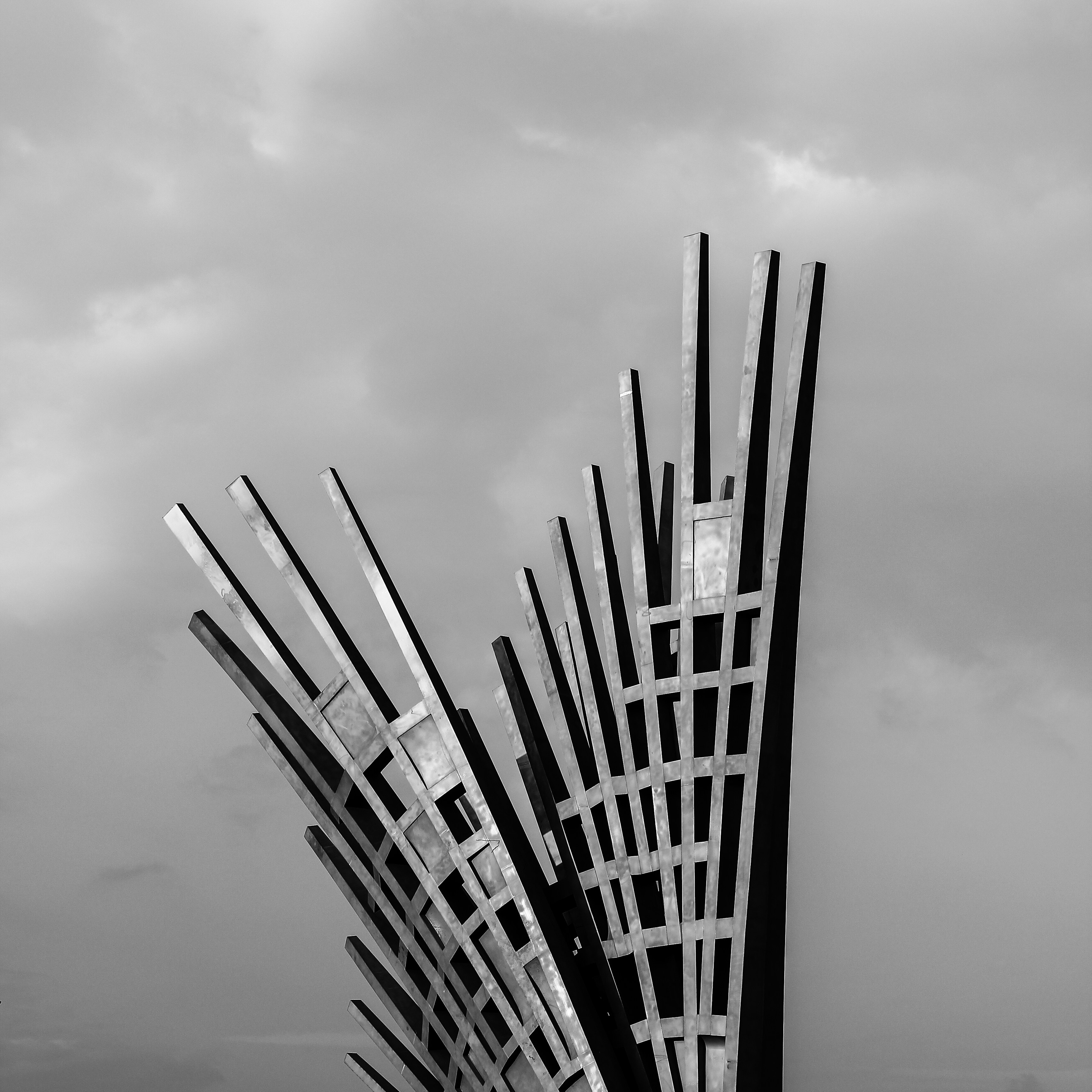 Converging Steel Fins: A Geometric Burst Against a Moody Sky