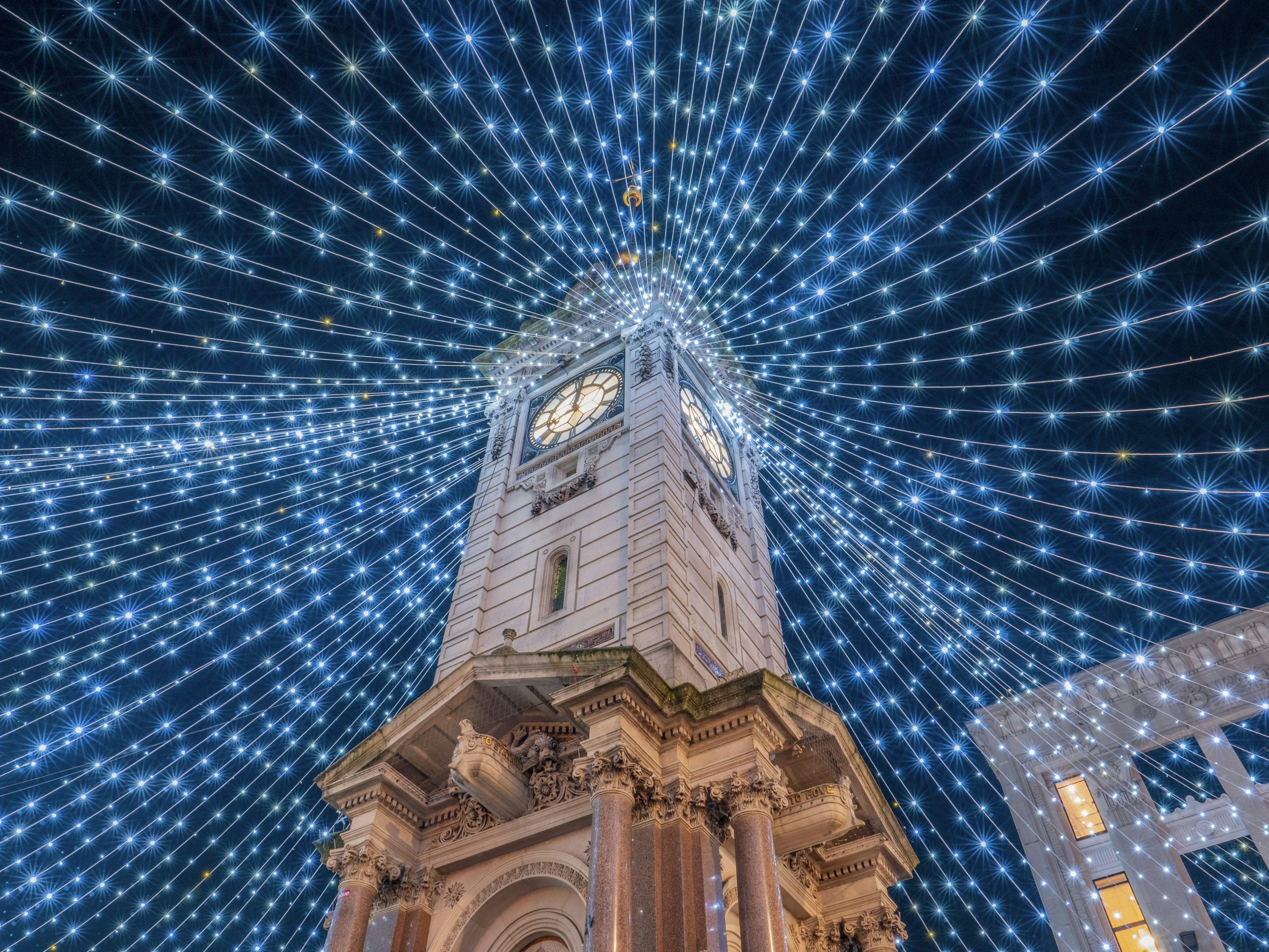 Clocktower Under a Sky of Electric Blue Constellations