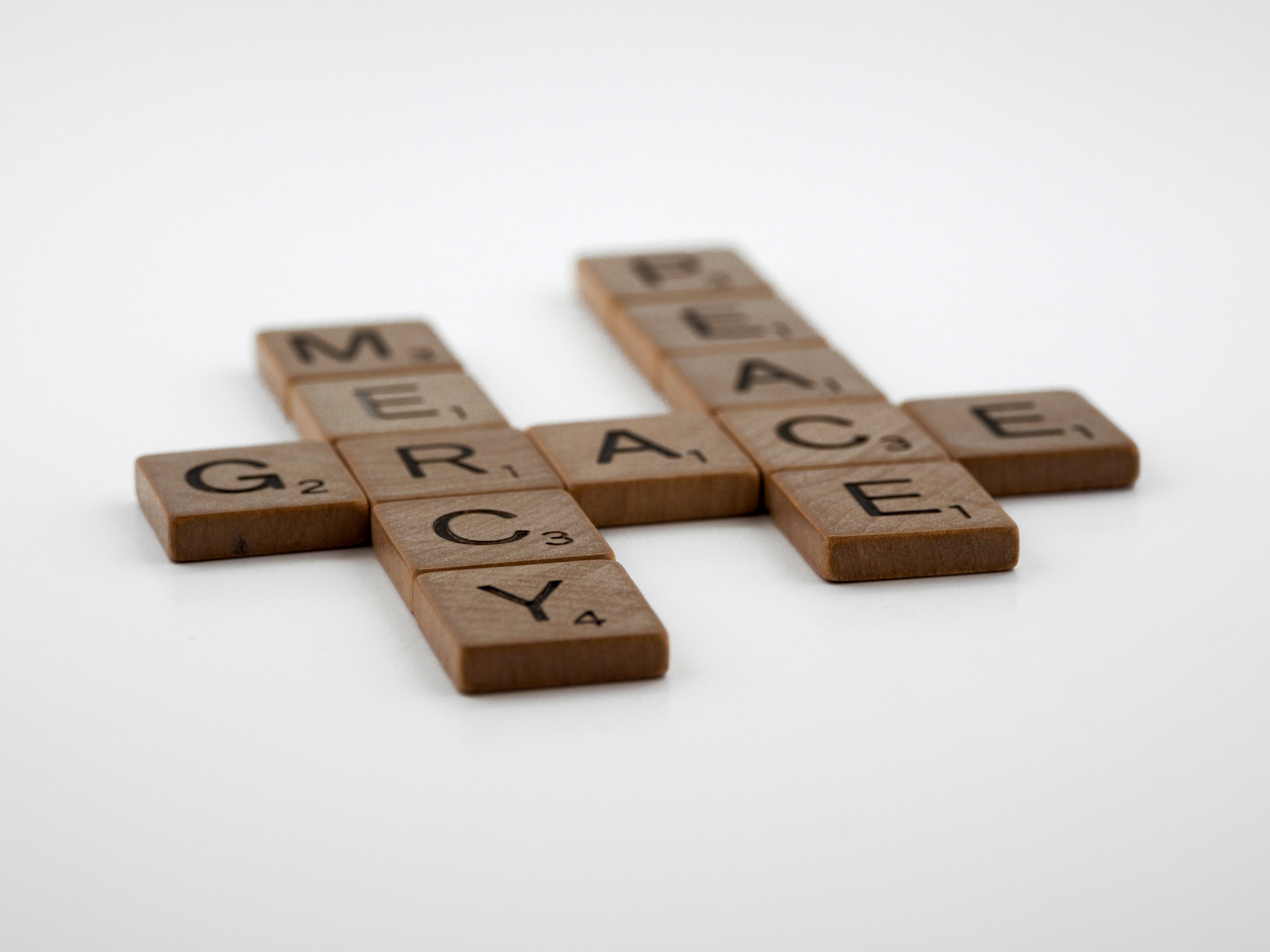 A cross made out of scrabble tiles with the words grace and y on photo ...