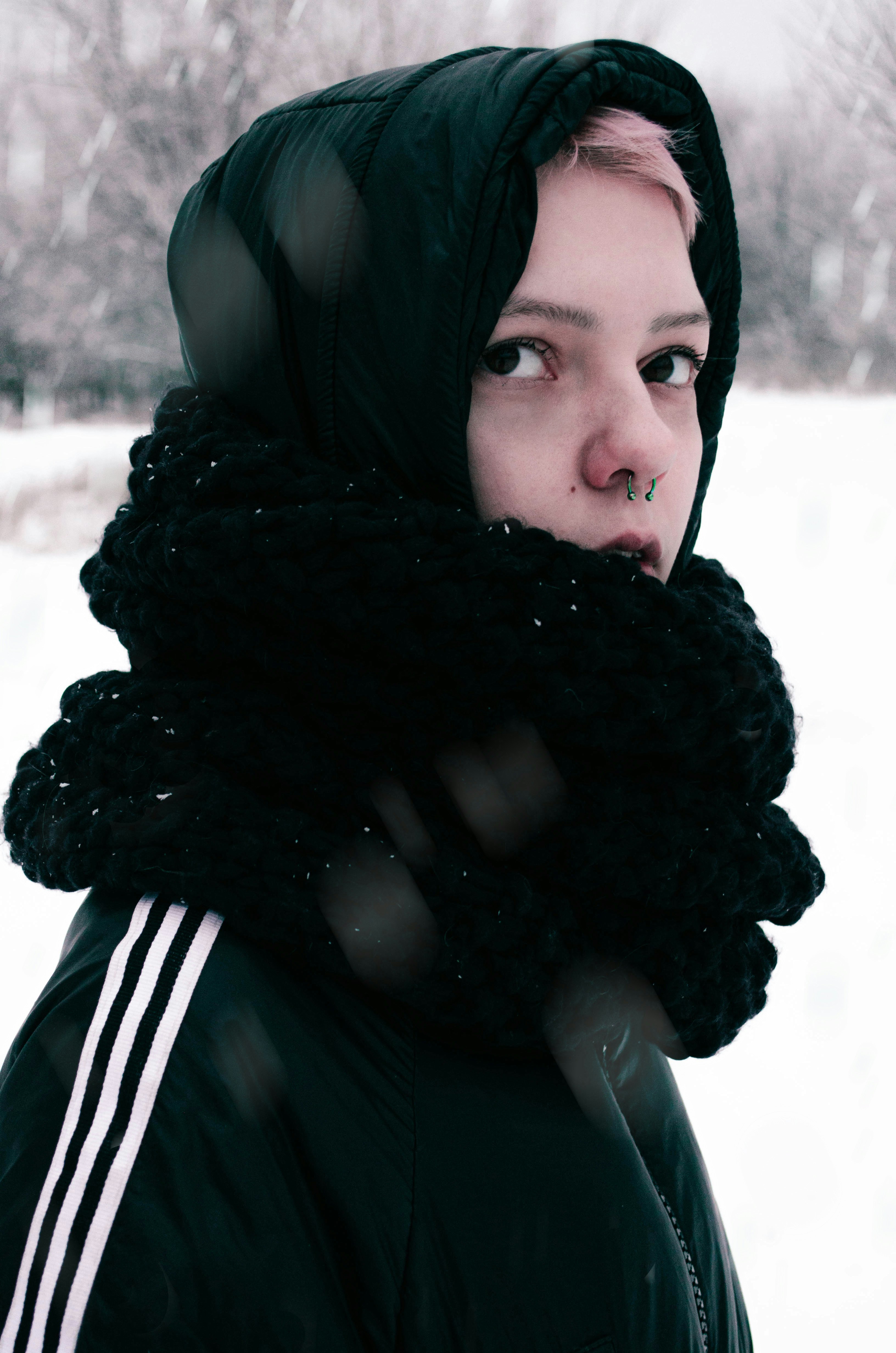 a woman wearing a black jacket and a black scarf