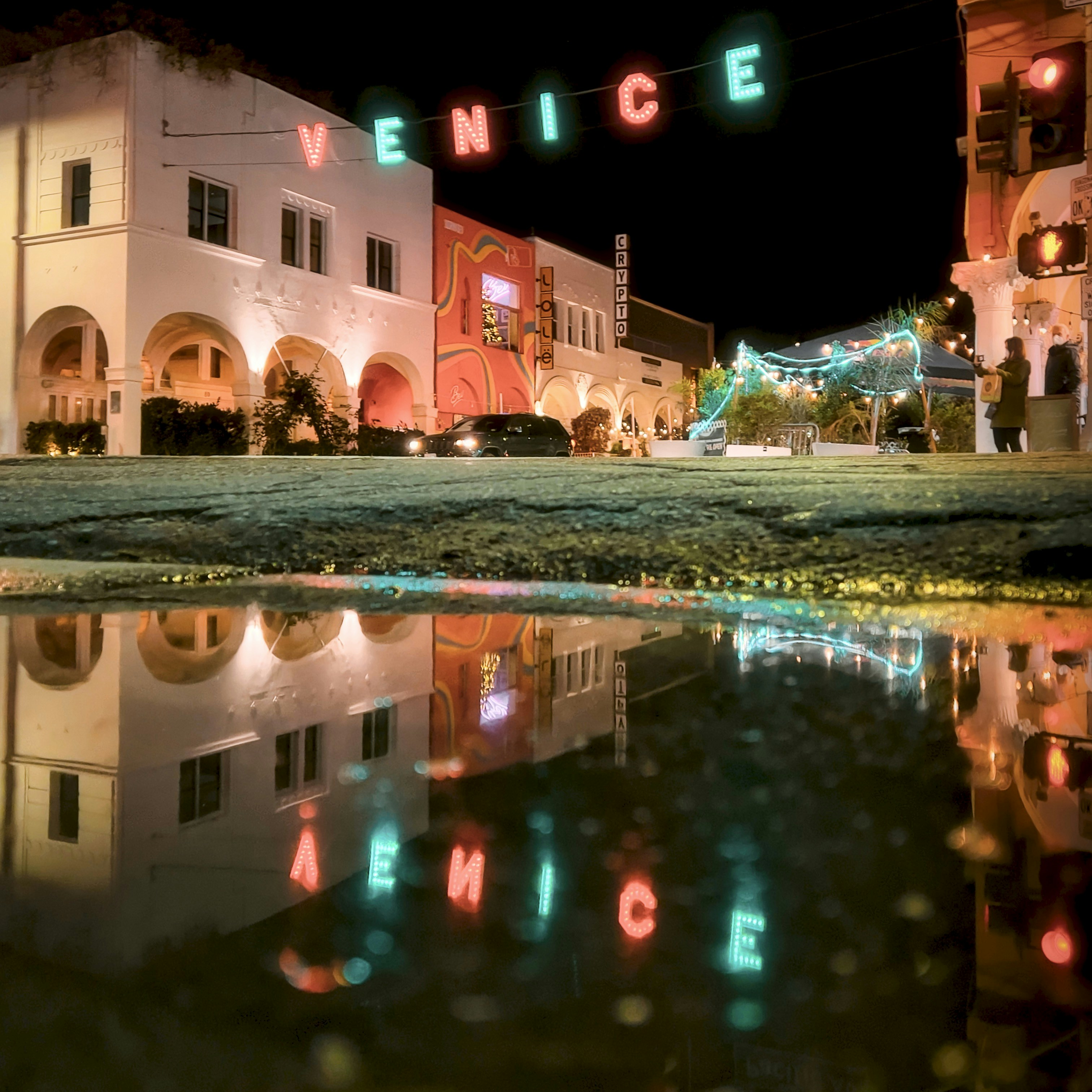Neon Venice Over a Midnight Puddle