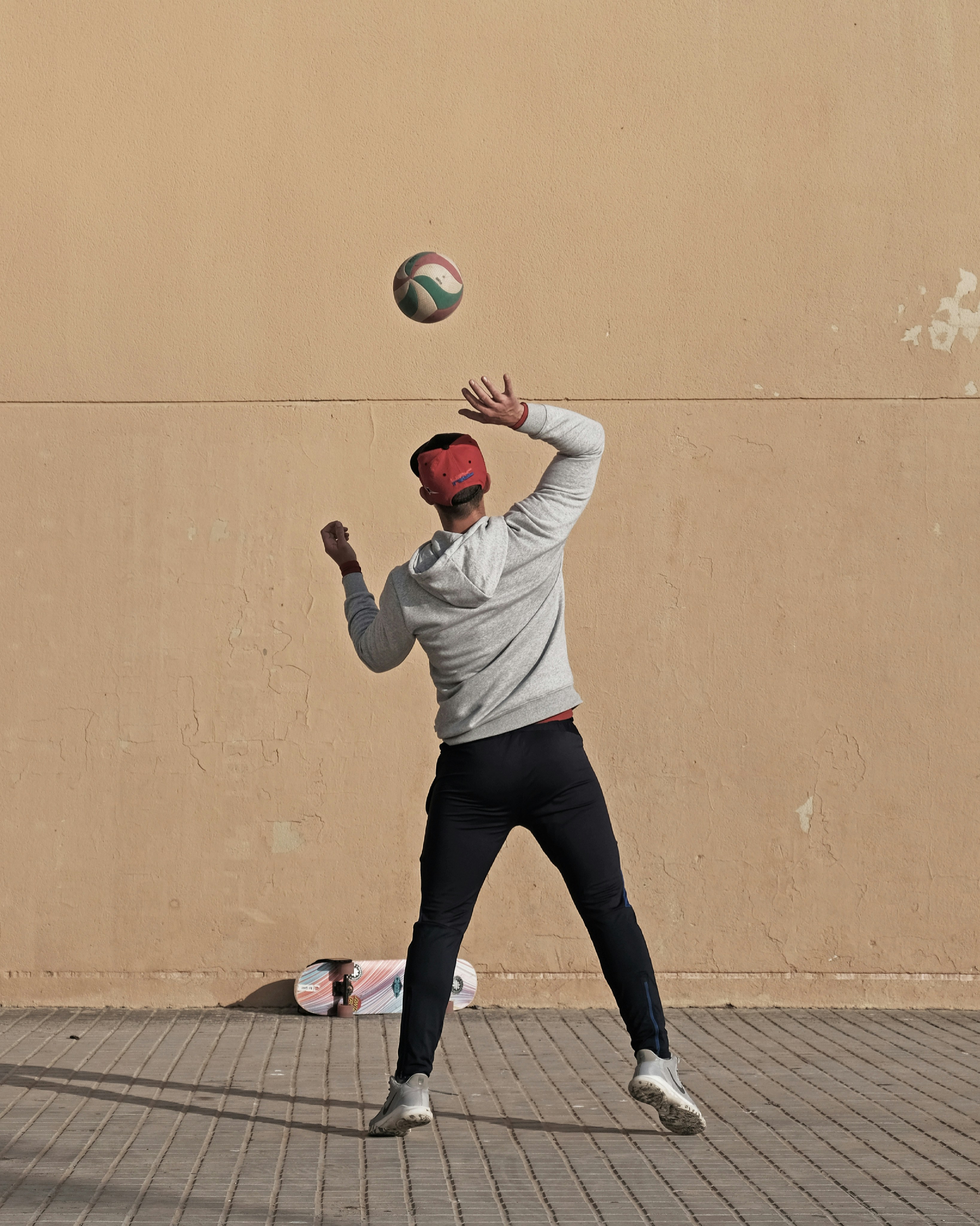 A man is playing with a ball in the street photo – Free Human Image on ...