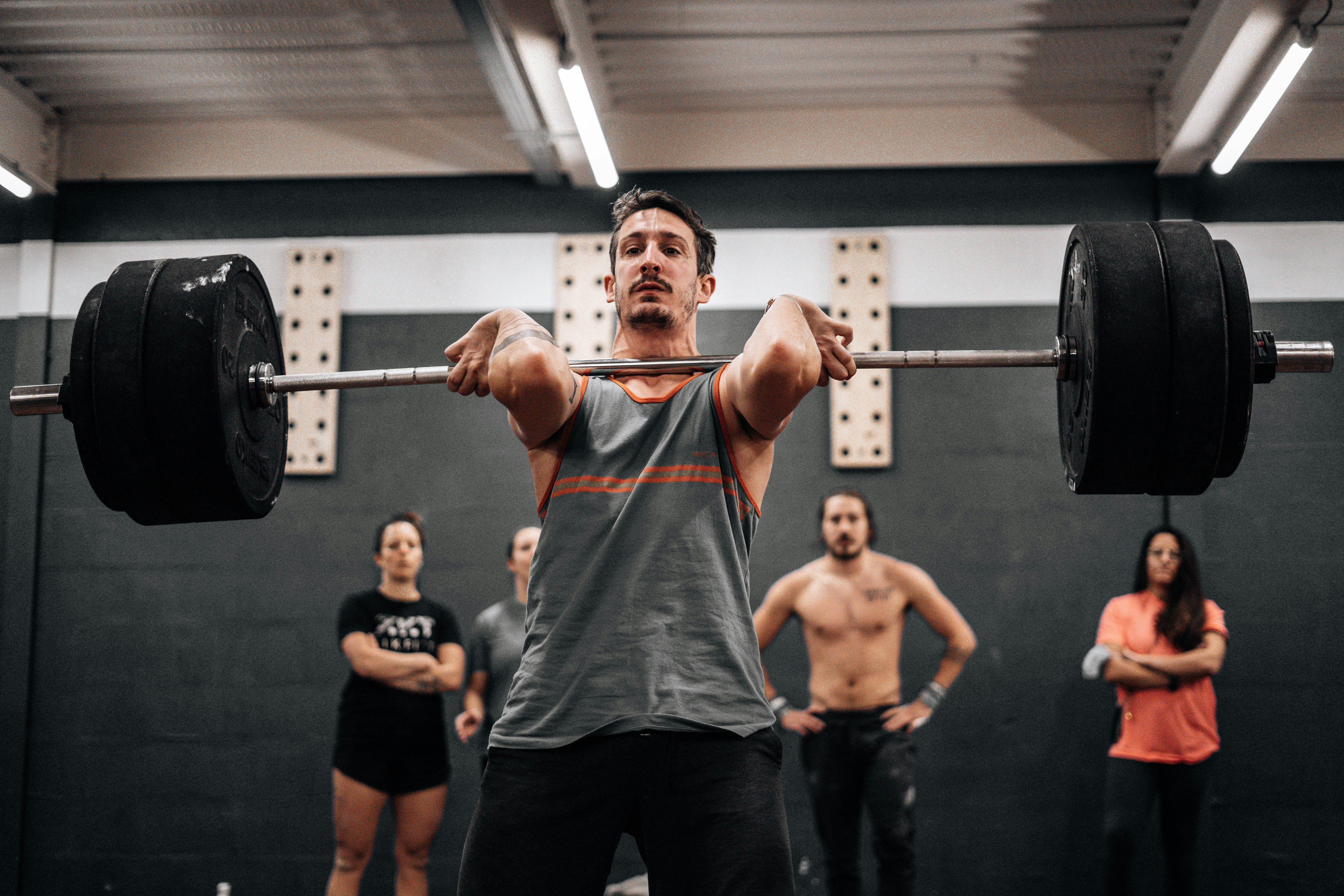 A man lifting a barbell in a gym photo – Free Human Image on Unsplash