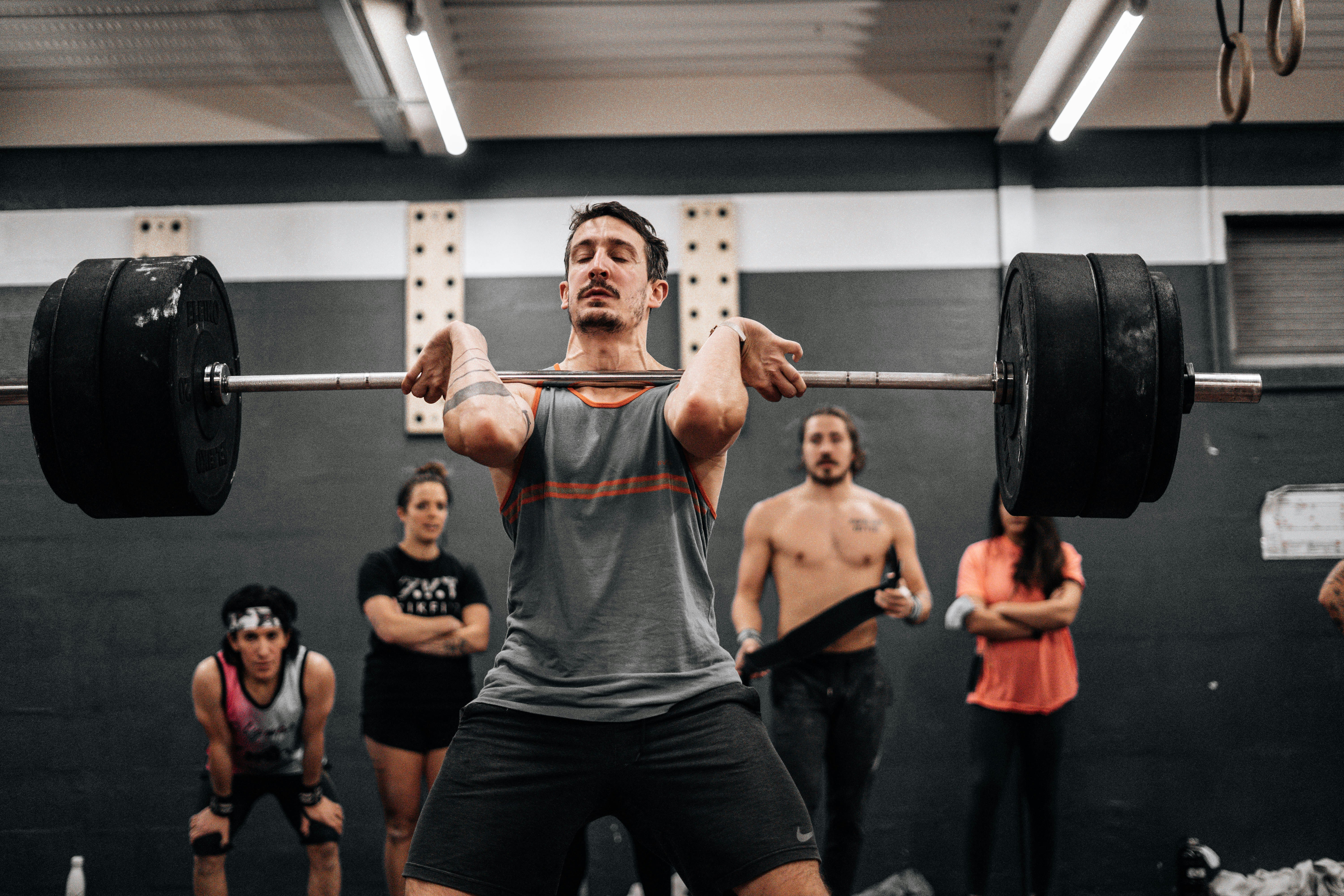 A man lifting a barbell in a gym photo – Free Human Image on Unsplash