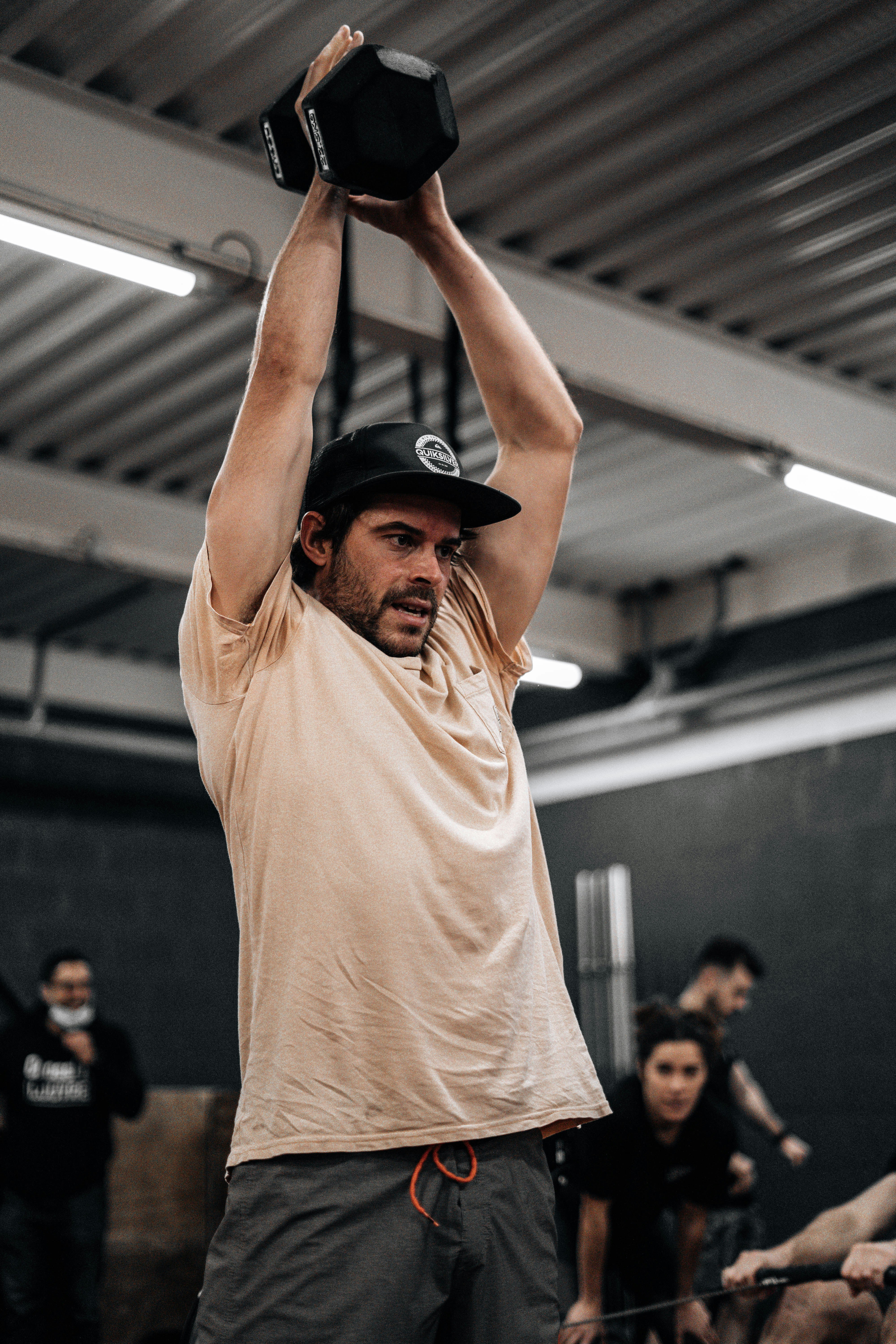 A man holding a black object above his head photo – Free Person Image ...