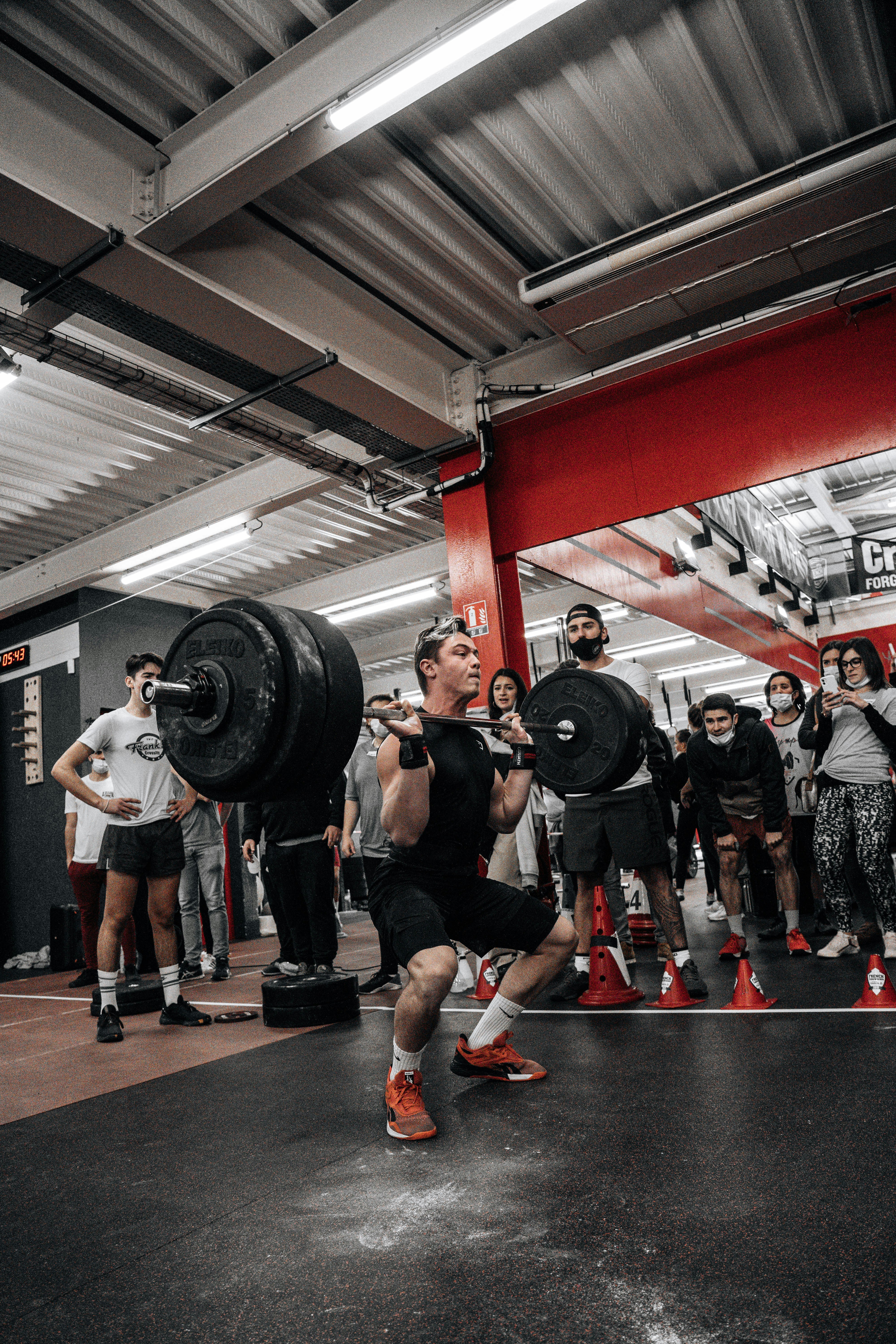 A man lifting a barbell in a gym photo – Free Human Image on Unsplash