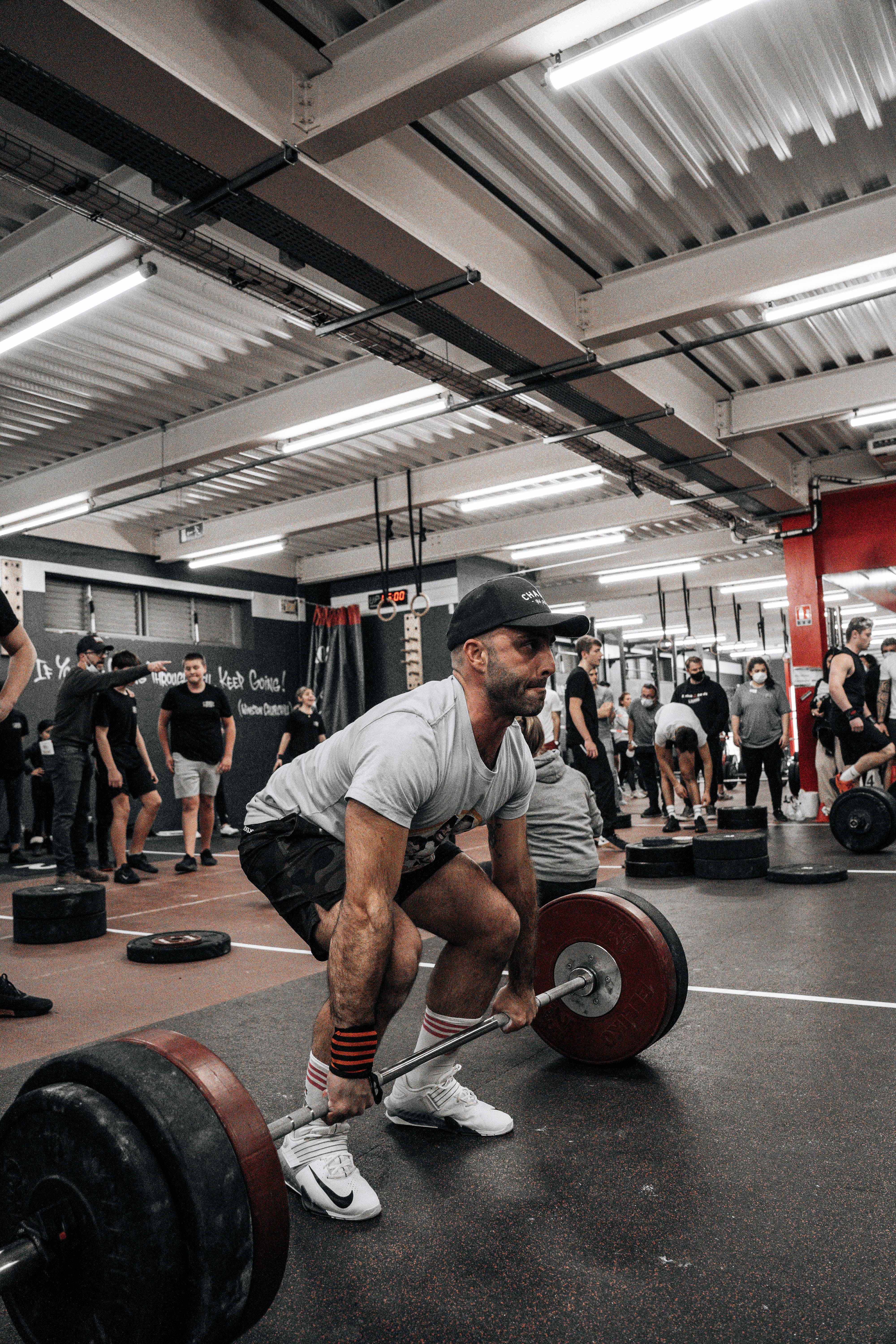 A man squatting on a barbell in a gym photo – Free Human Image on Unsplash
