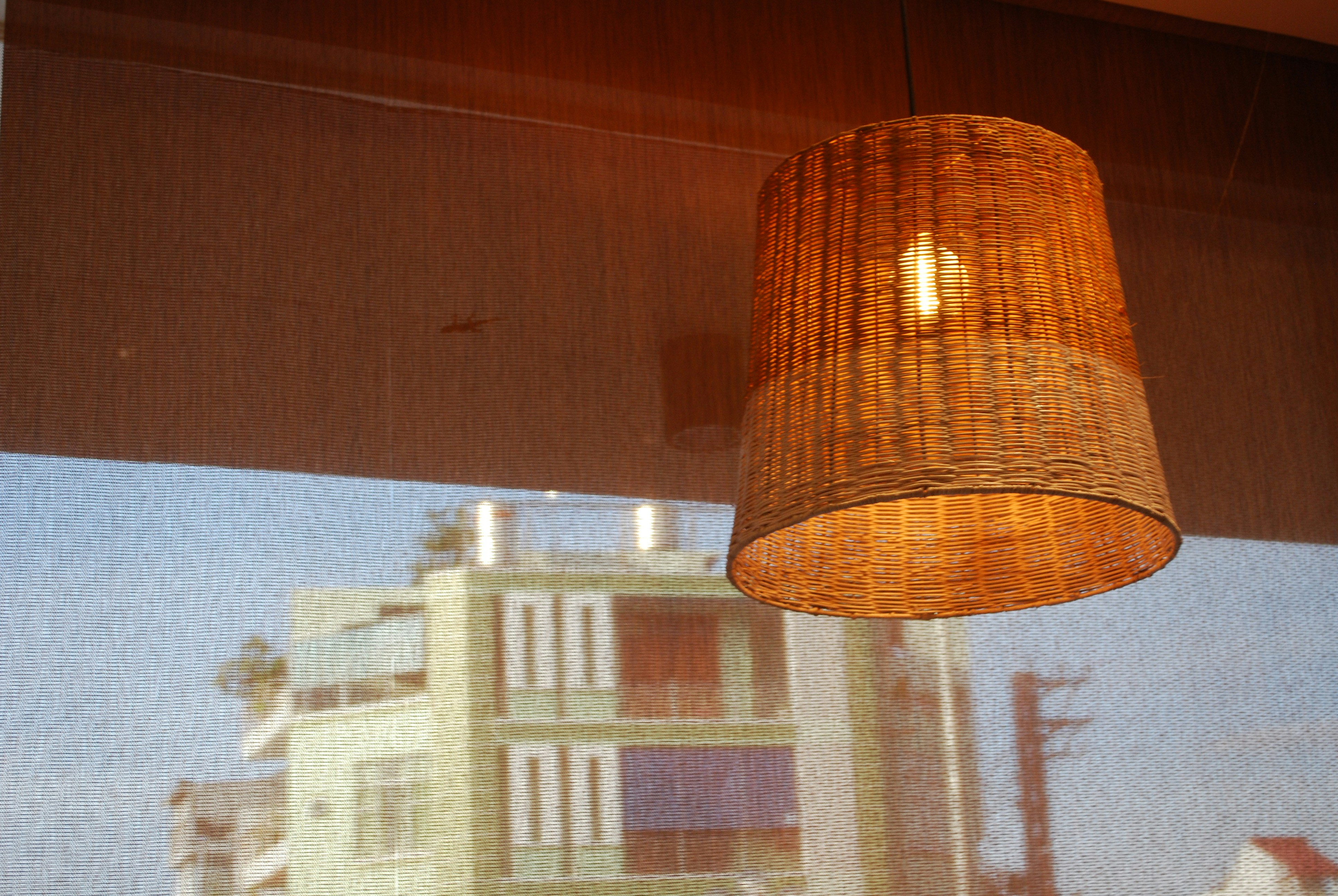 a lamp hanging from a window next to a building