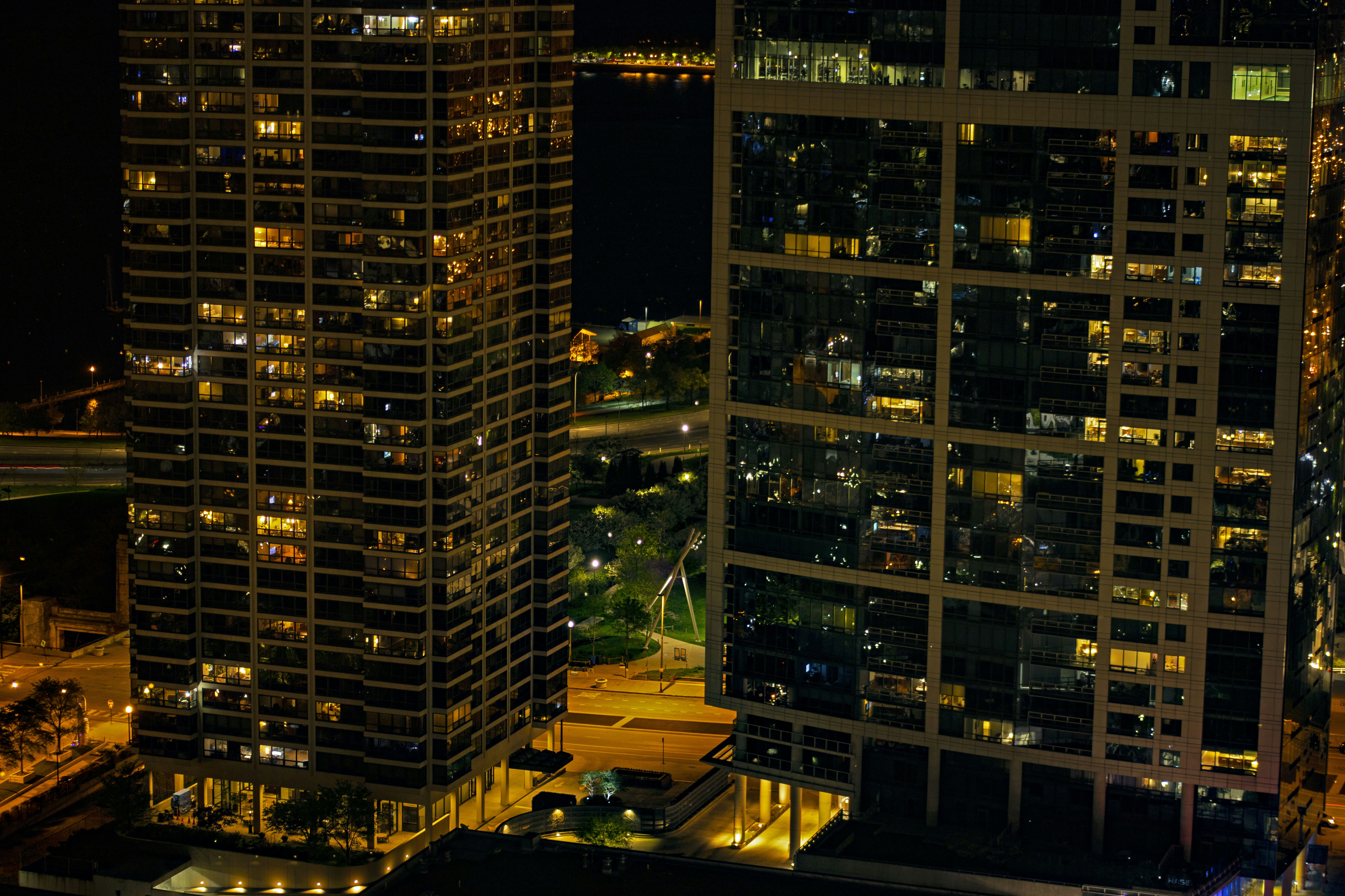 A view of a city at night from the top of a building photo – Free Land ...