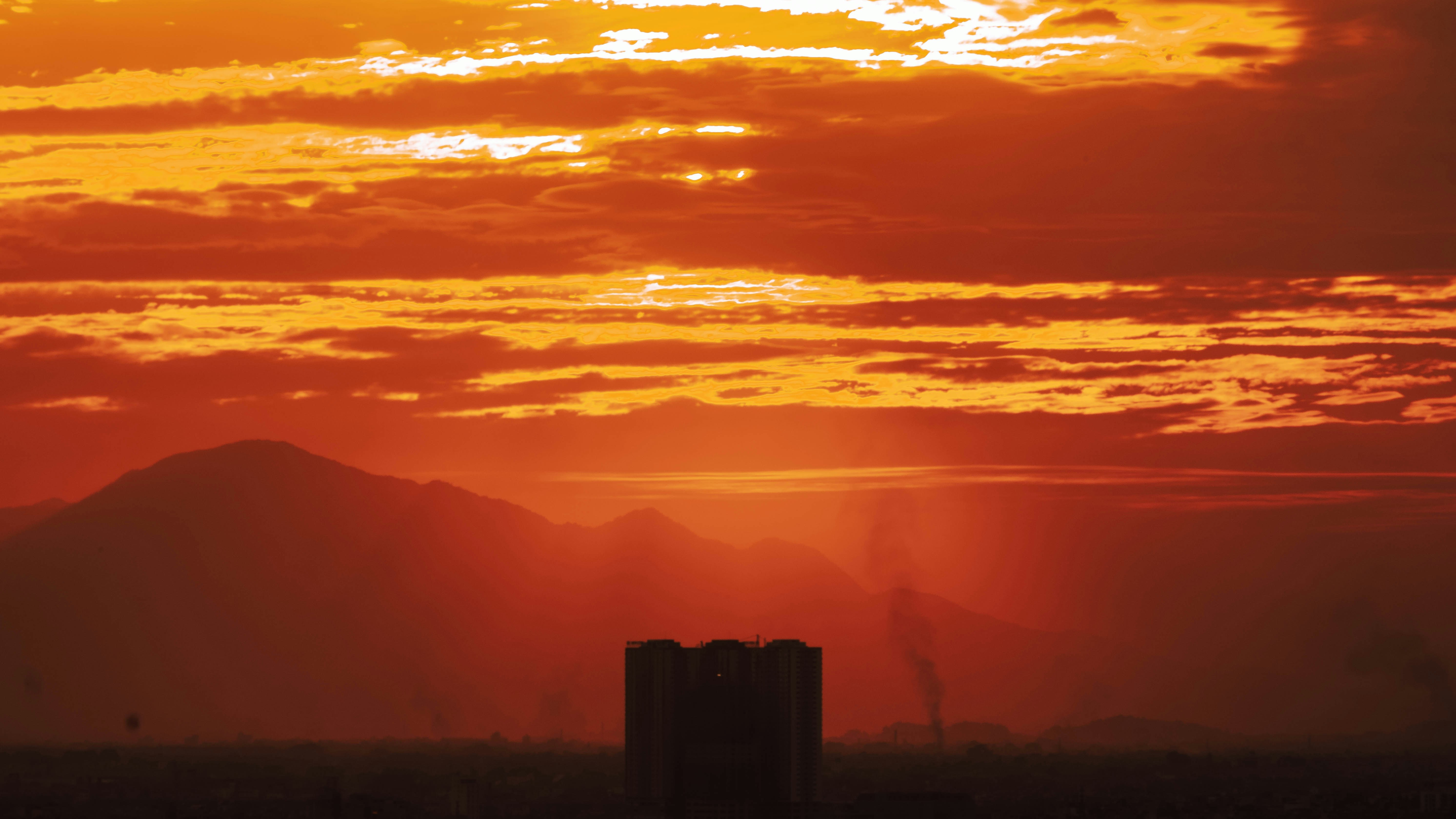 Crimson Dusk Over a Silent Monolith